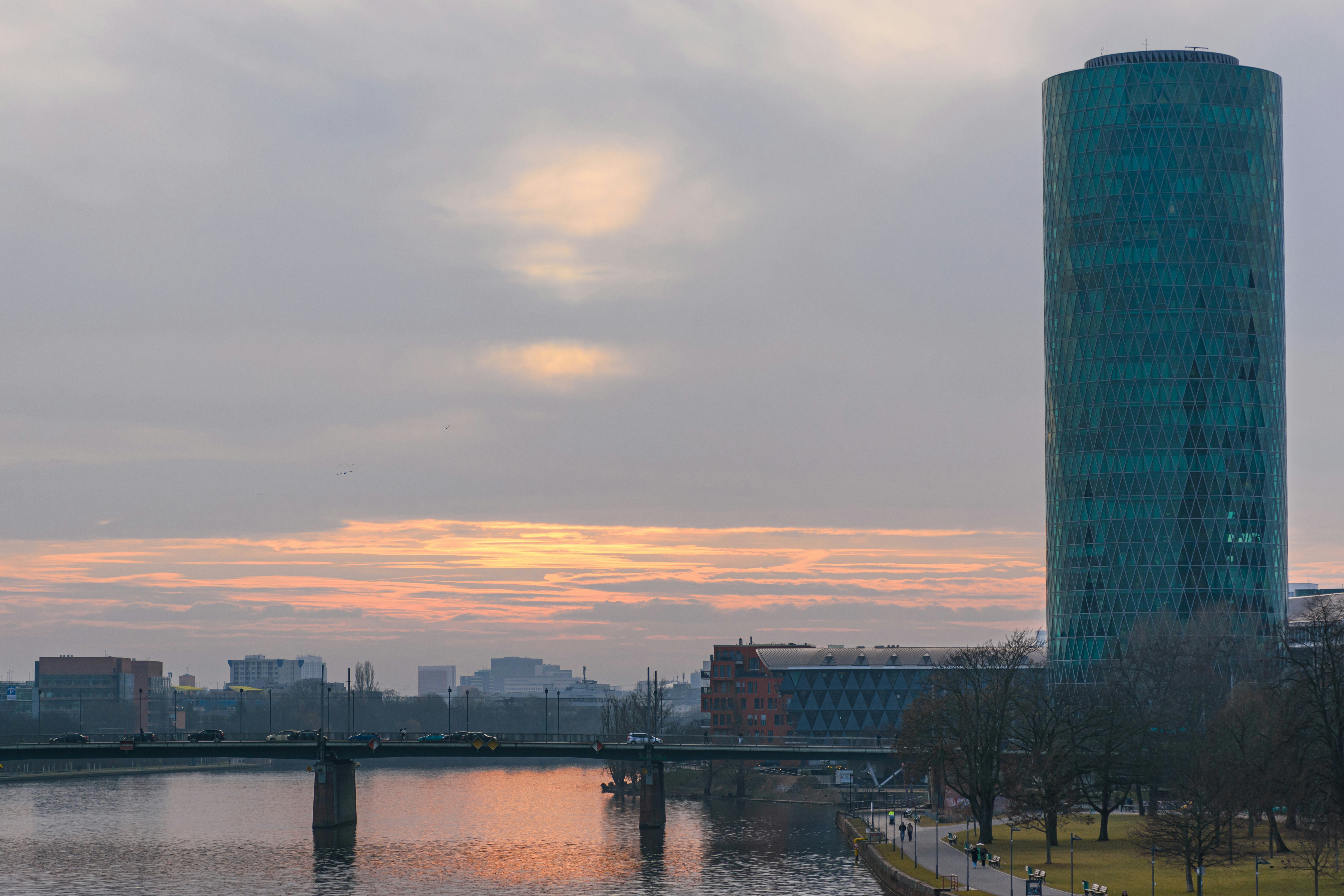 Silvery River Reflections by a Modern Tower