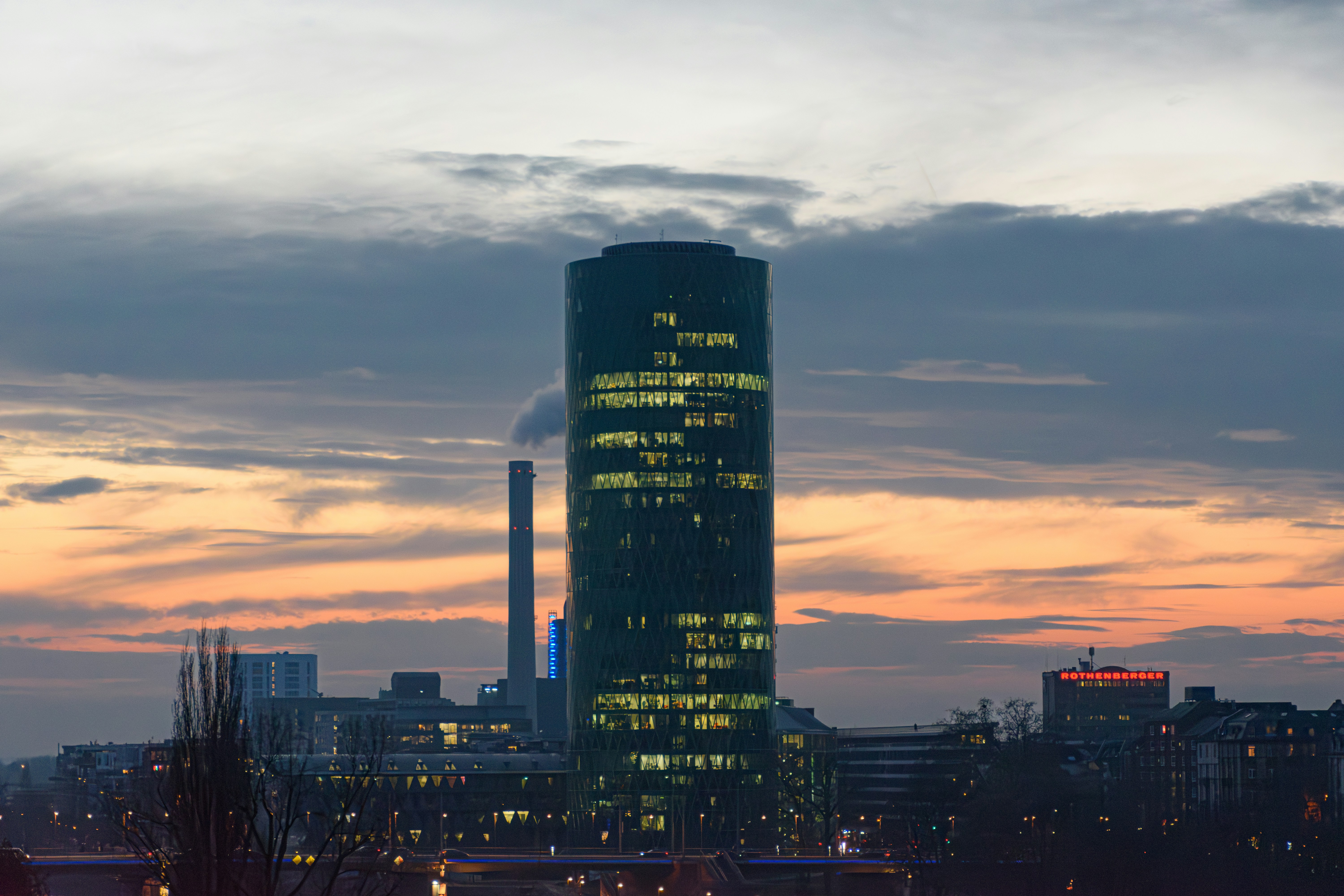 Rising Glass: Evening Skyline Framed by a Silhouetted Horizon