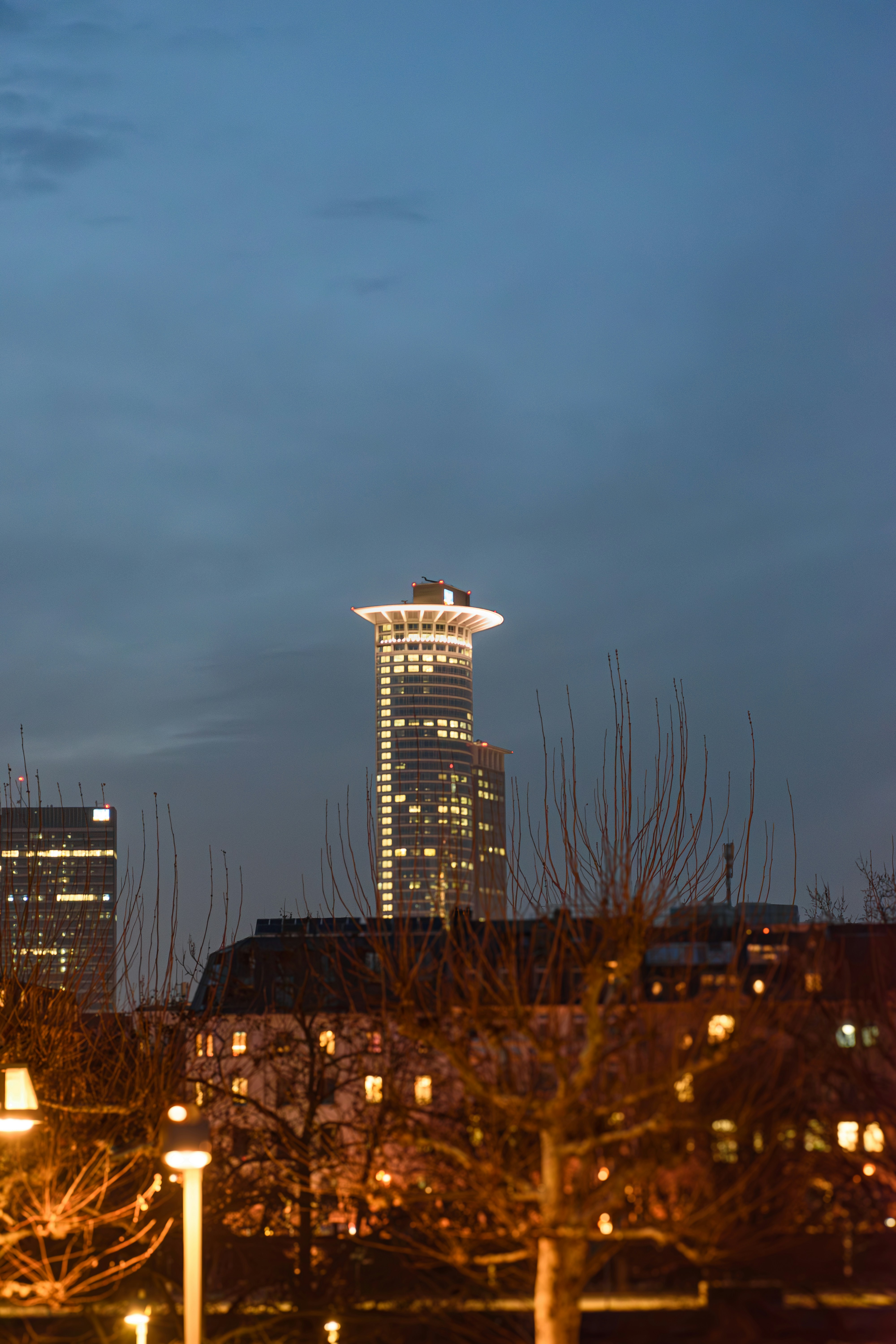 City Tower with Warm Street Lights under Dusk Sky