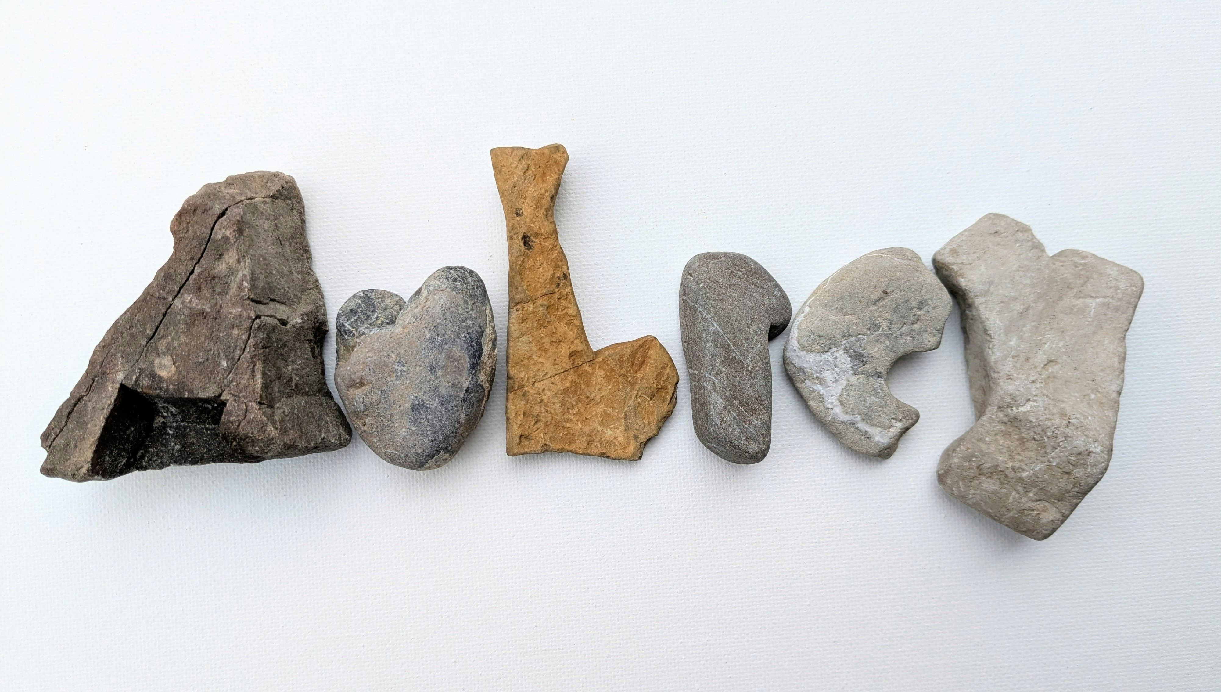 Rock-letter Mosaic: Spelling 'HOLICY' in Stone