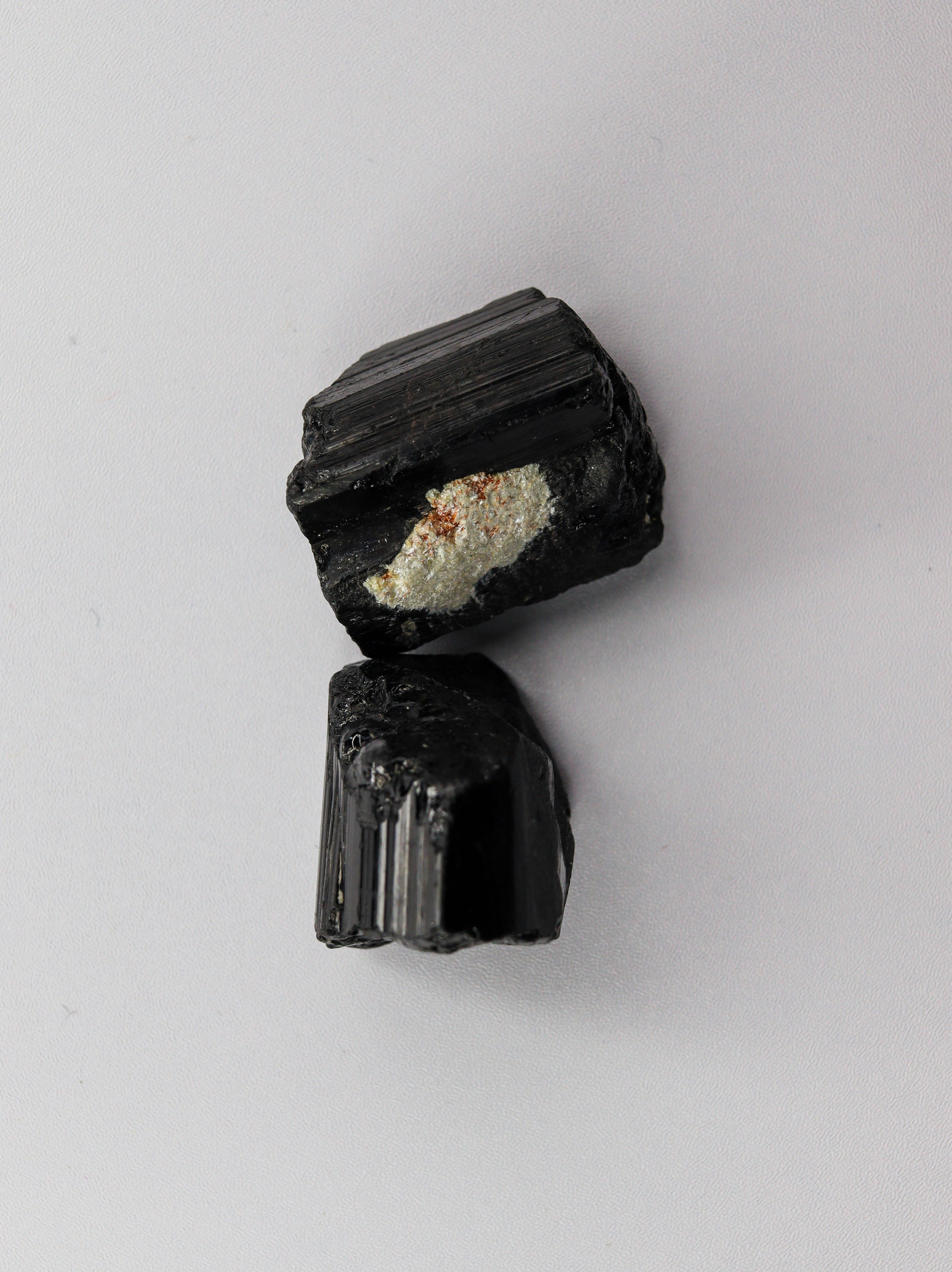 Charred Fragments of Black Tourmaline on Shaped White Surface
