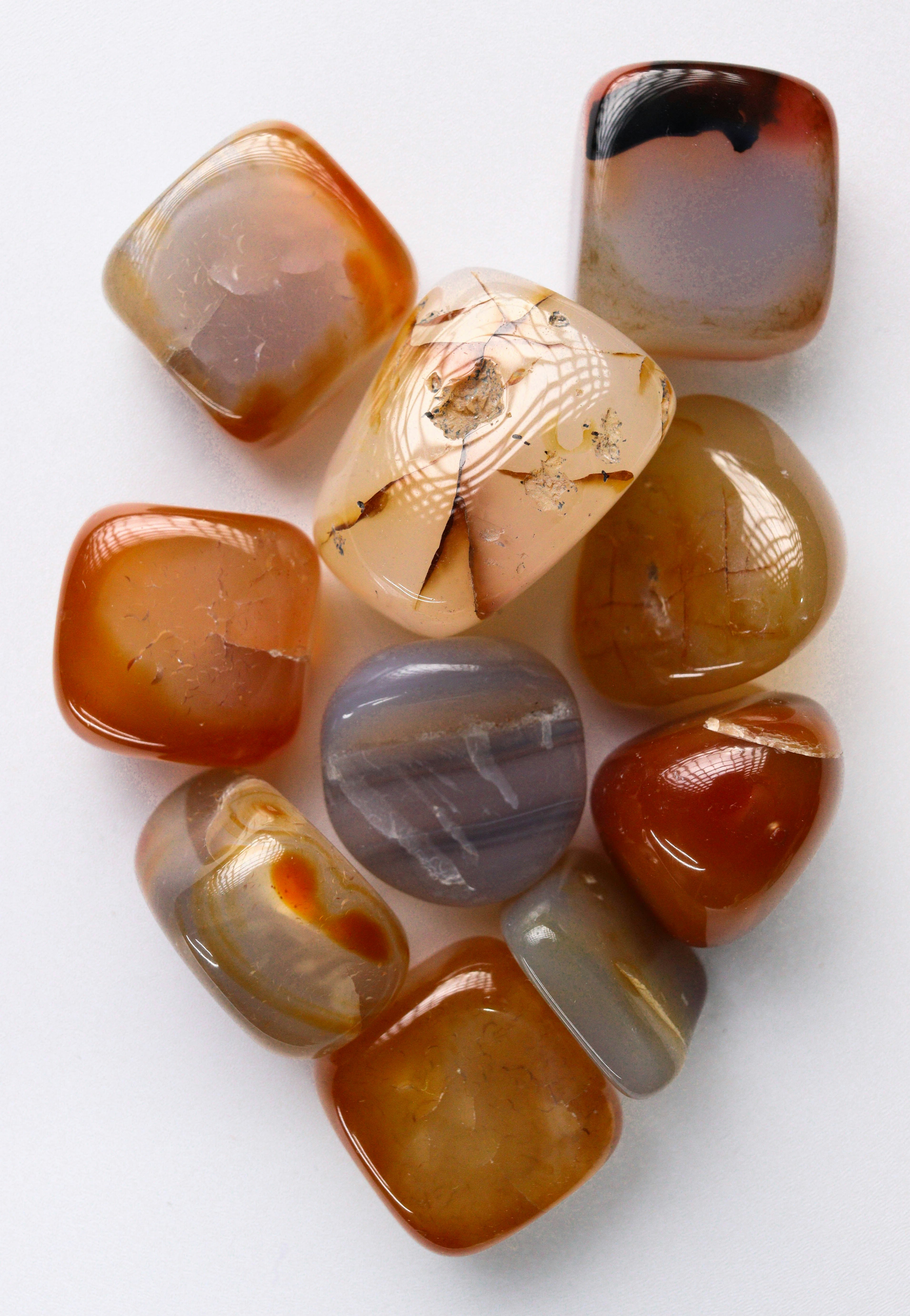 A collection of polished agate stones on a white background.