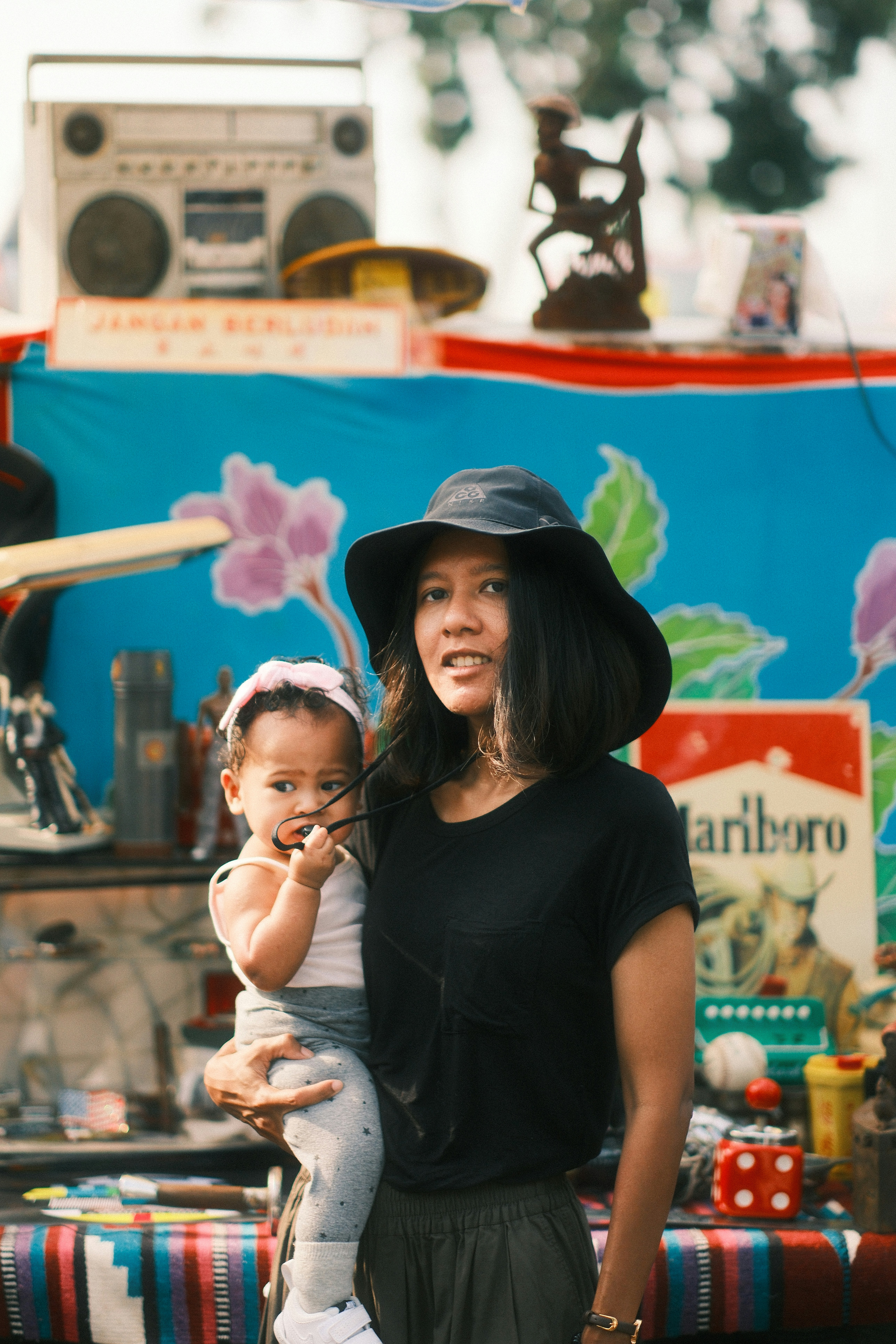 Mother and Child at a Colorful Street Booth