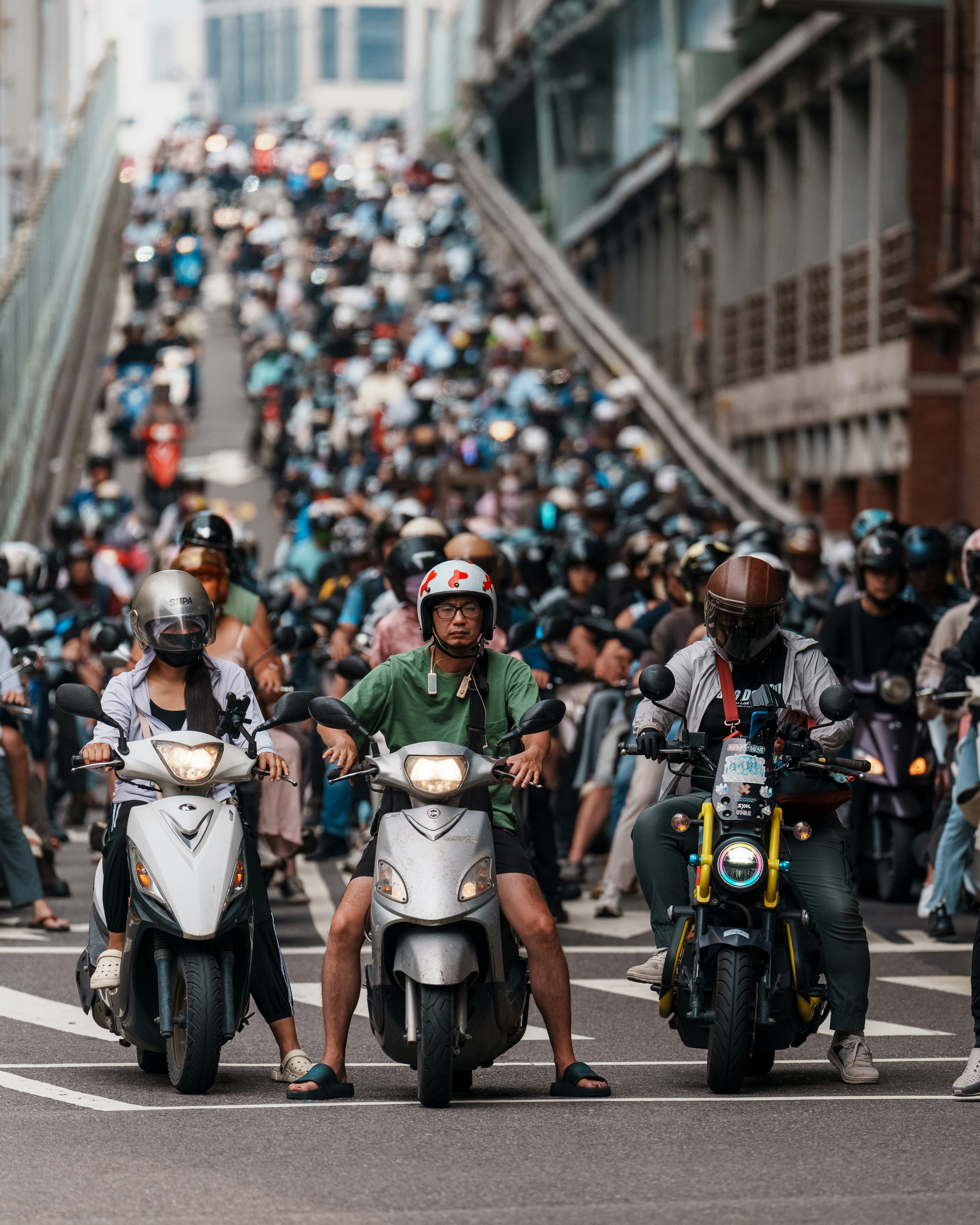 Frontline Confluence: Riders Amid a City Flood of Pedestrians