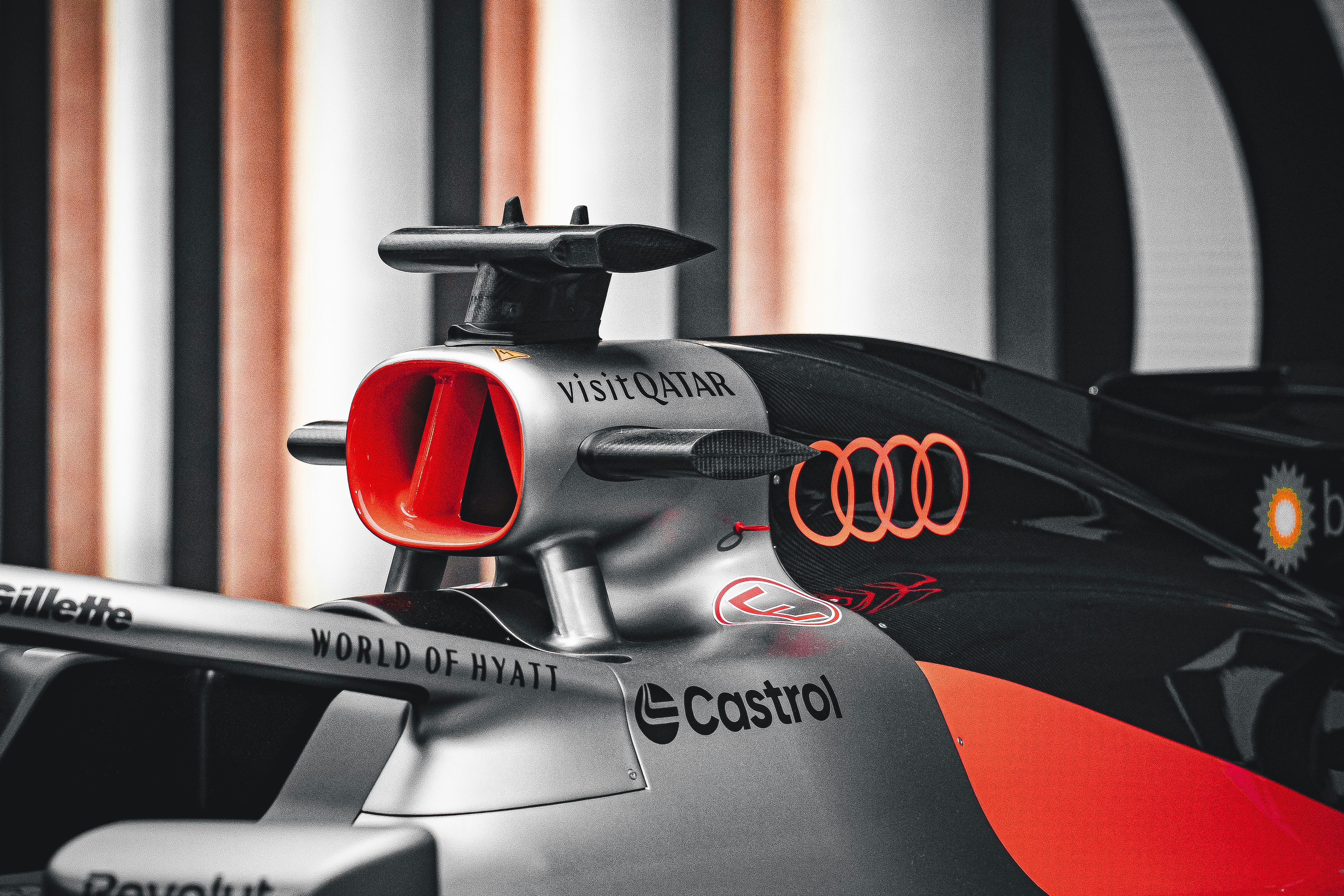 Close-Up of a Formula Car Cockpit: The Red Intake and Sponsor Details