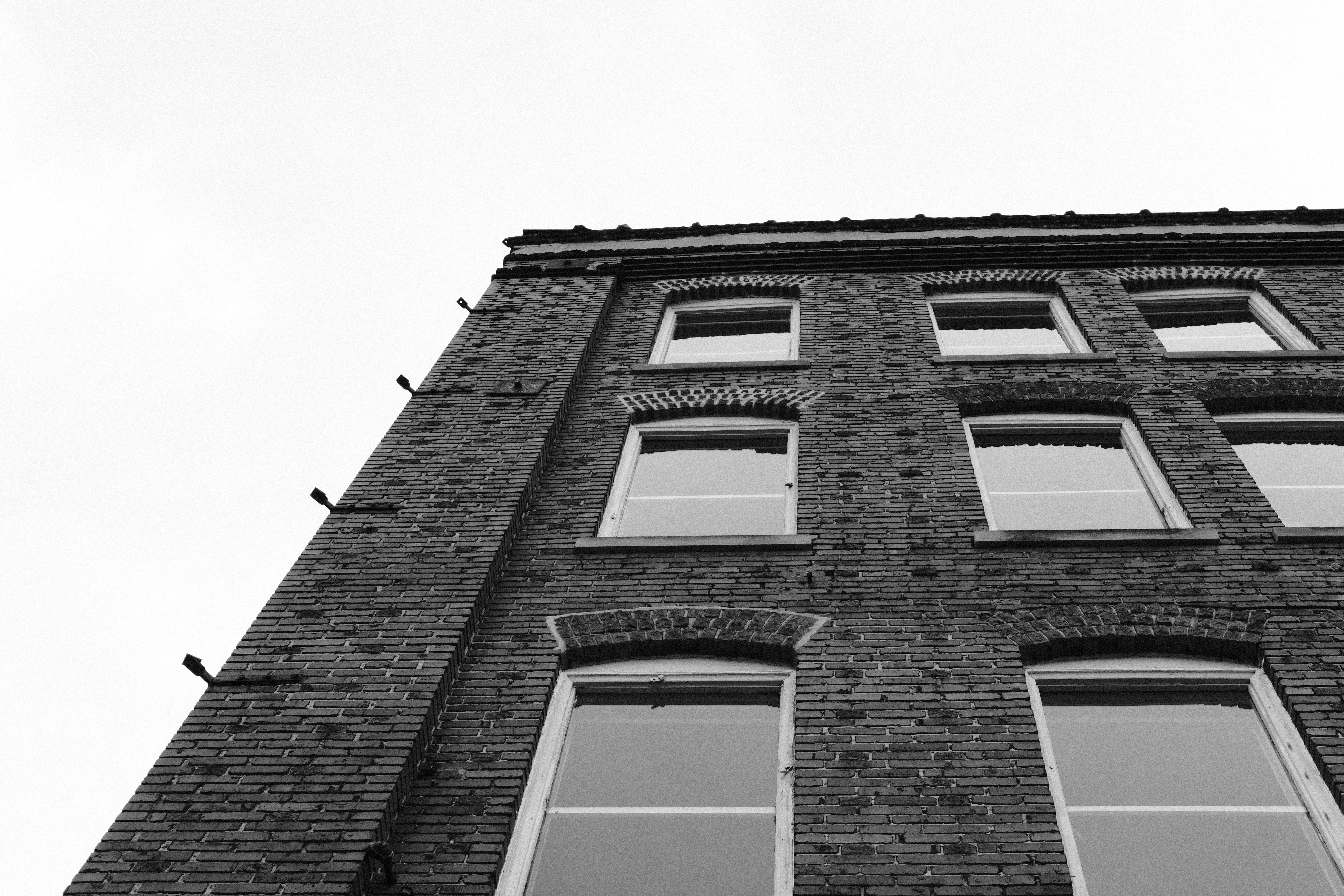Brick Corner Ascent: A Black-and-White Facade Reaching Skyward