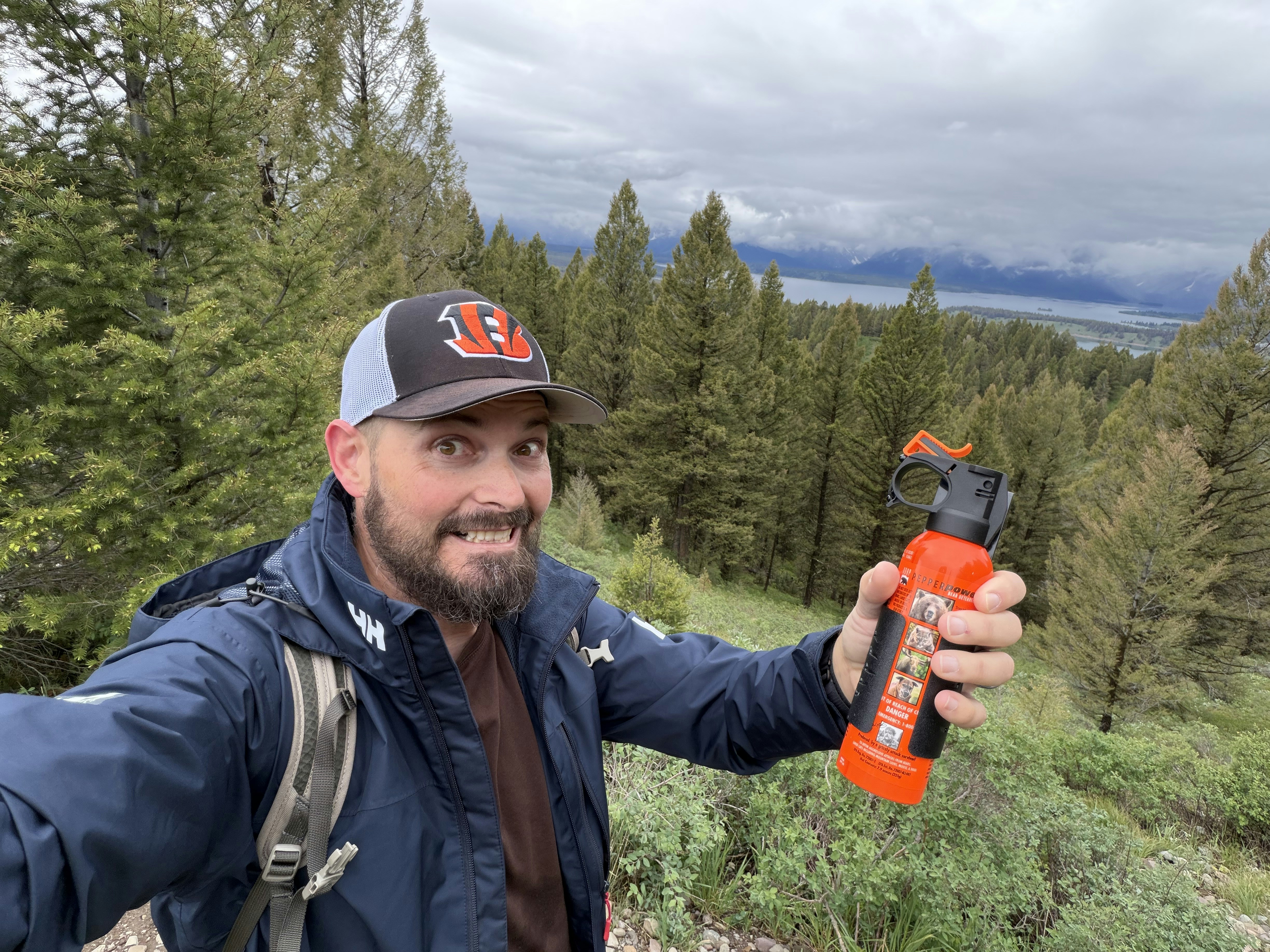 Selfie with a Fiery Hydration Companion on a Pine-blanketed Ridge