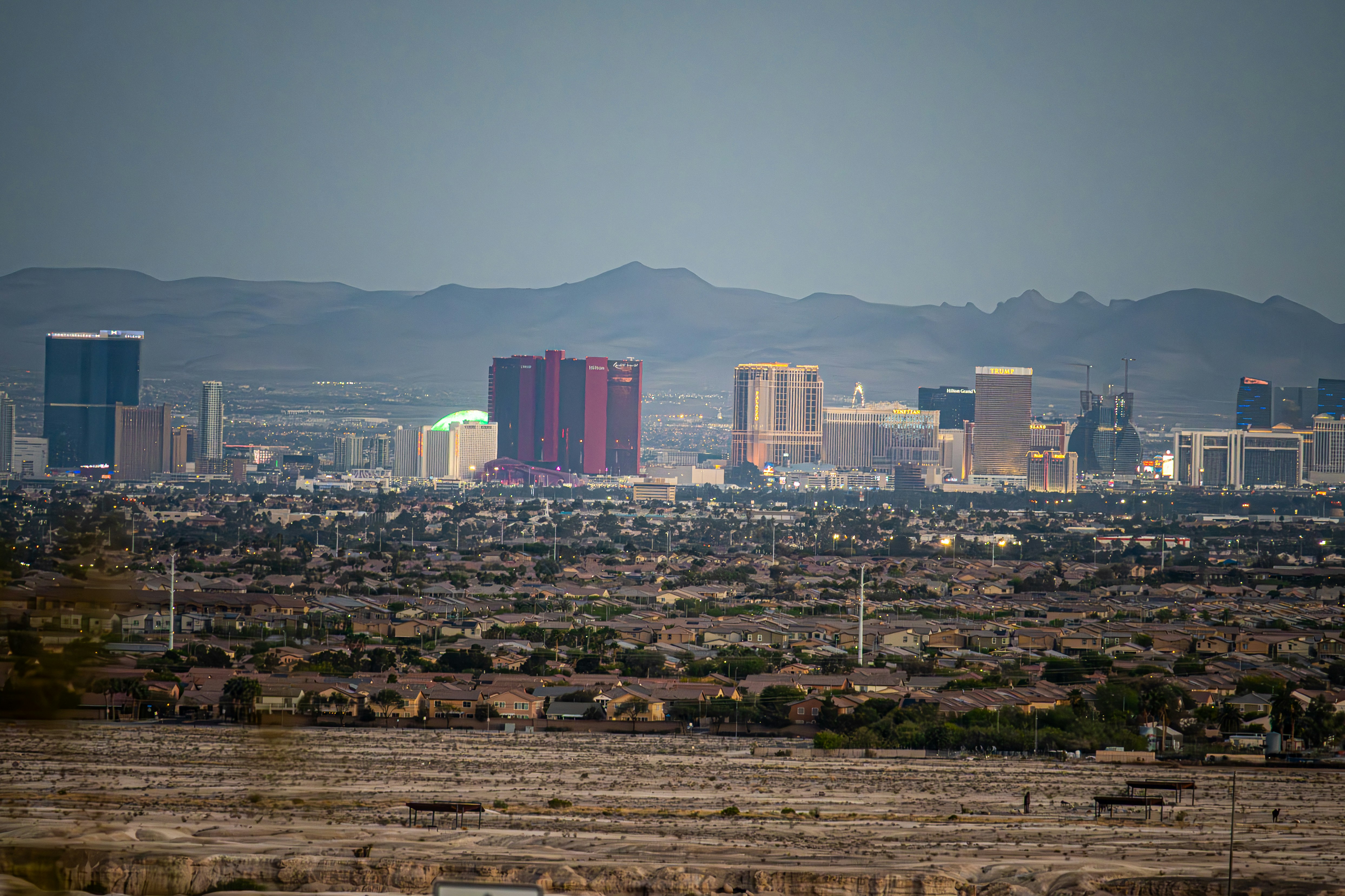 Desert Mirage: City Silhouette Rising Beyond Arid Flats