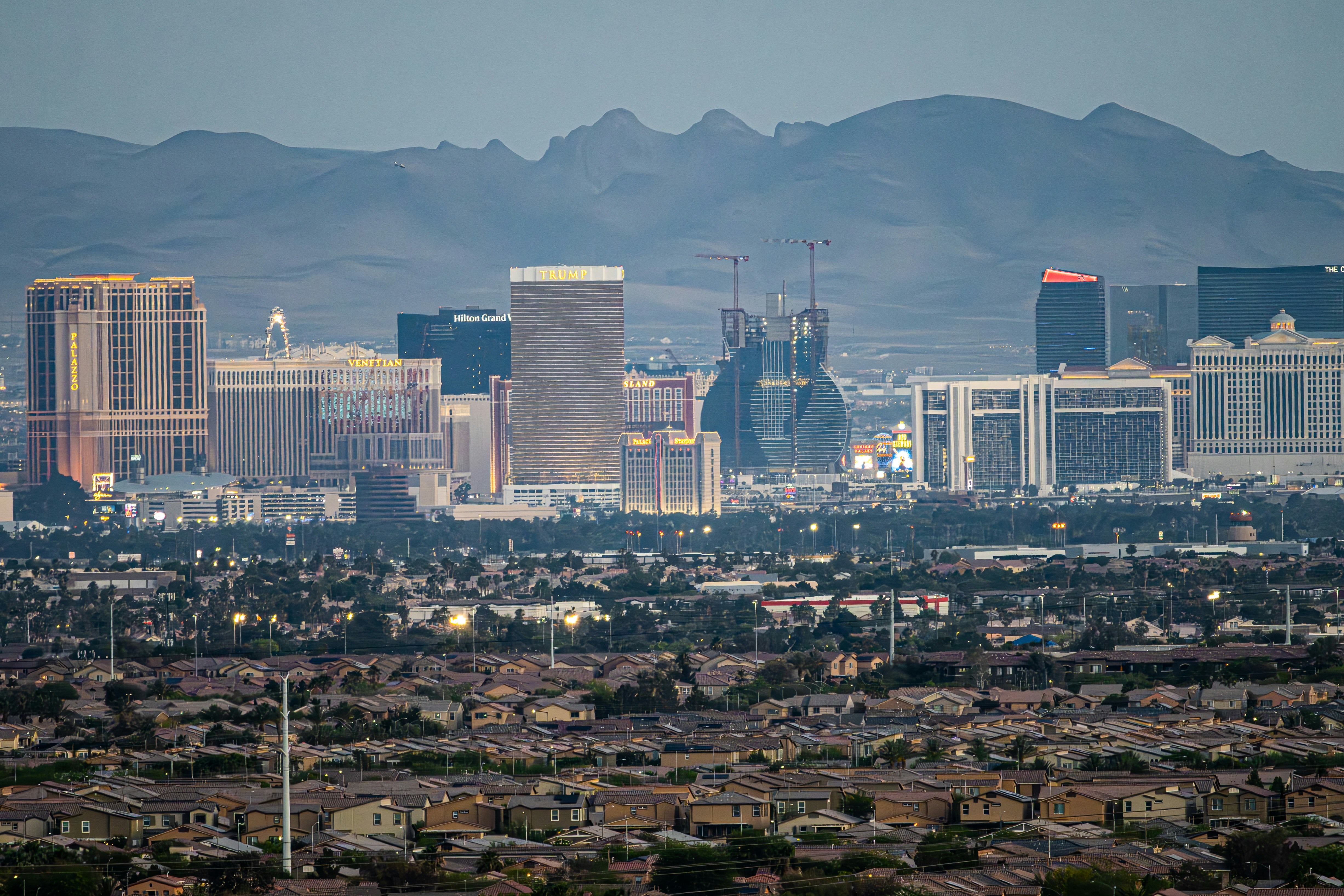 Urban Mirage: The Desert Skyline Under a Cascade of Distant Peaks