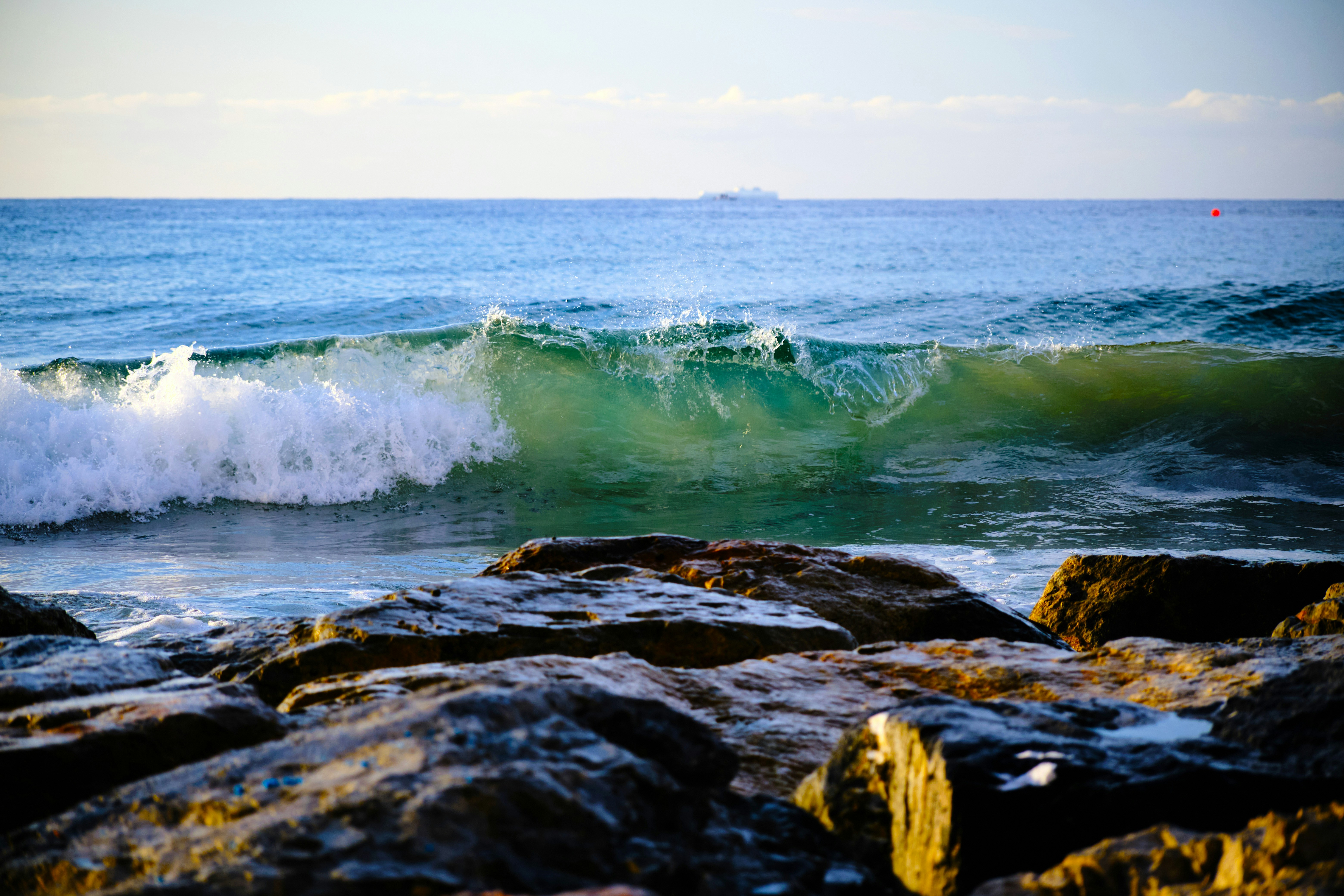 Foamy Atlantic Crest over Weathered Rocks