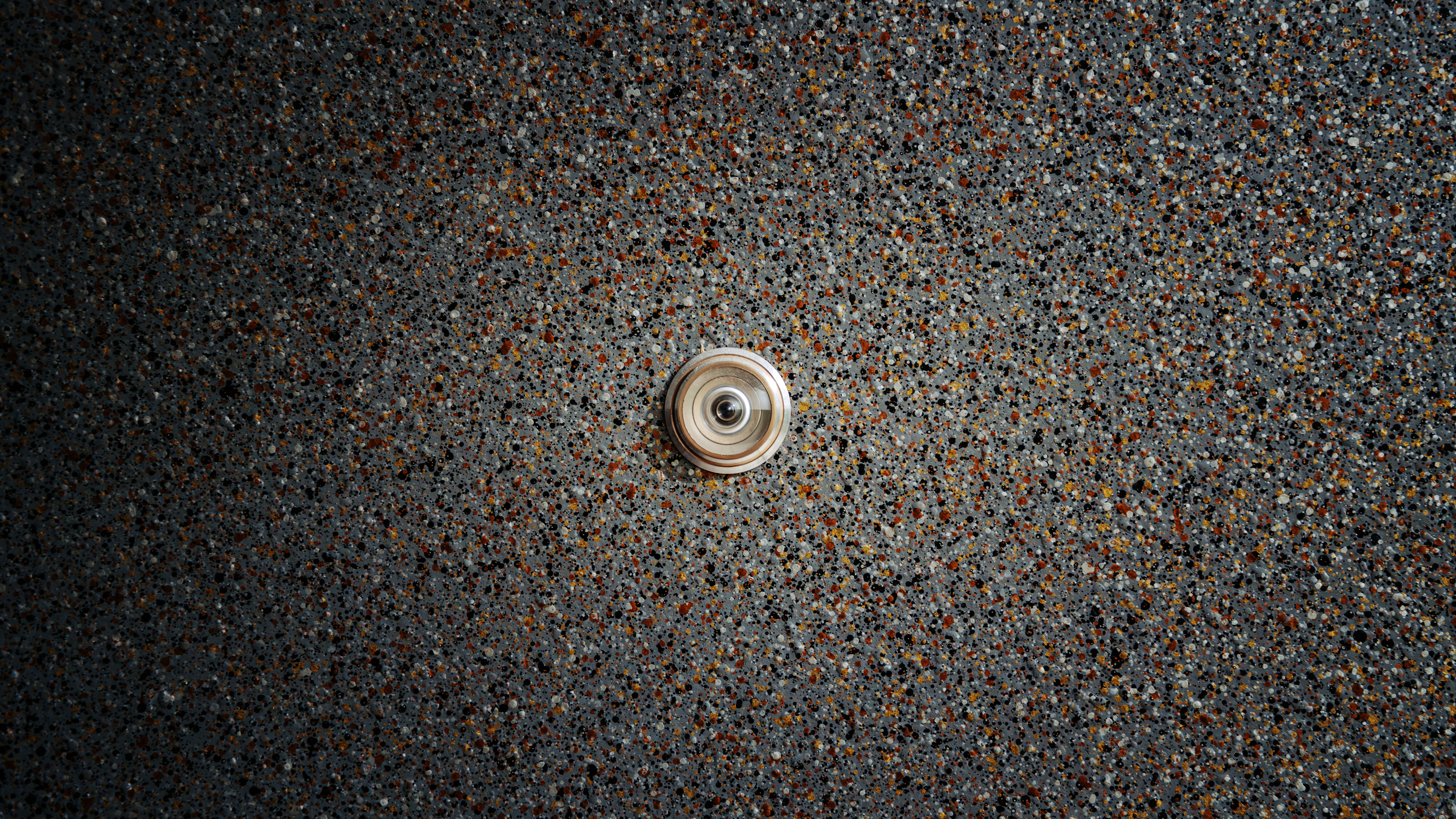 Centered Emitter: A Close-Up of a Small Metal Valve on Gravel