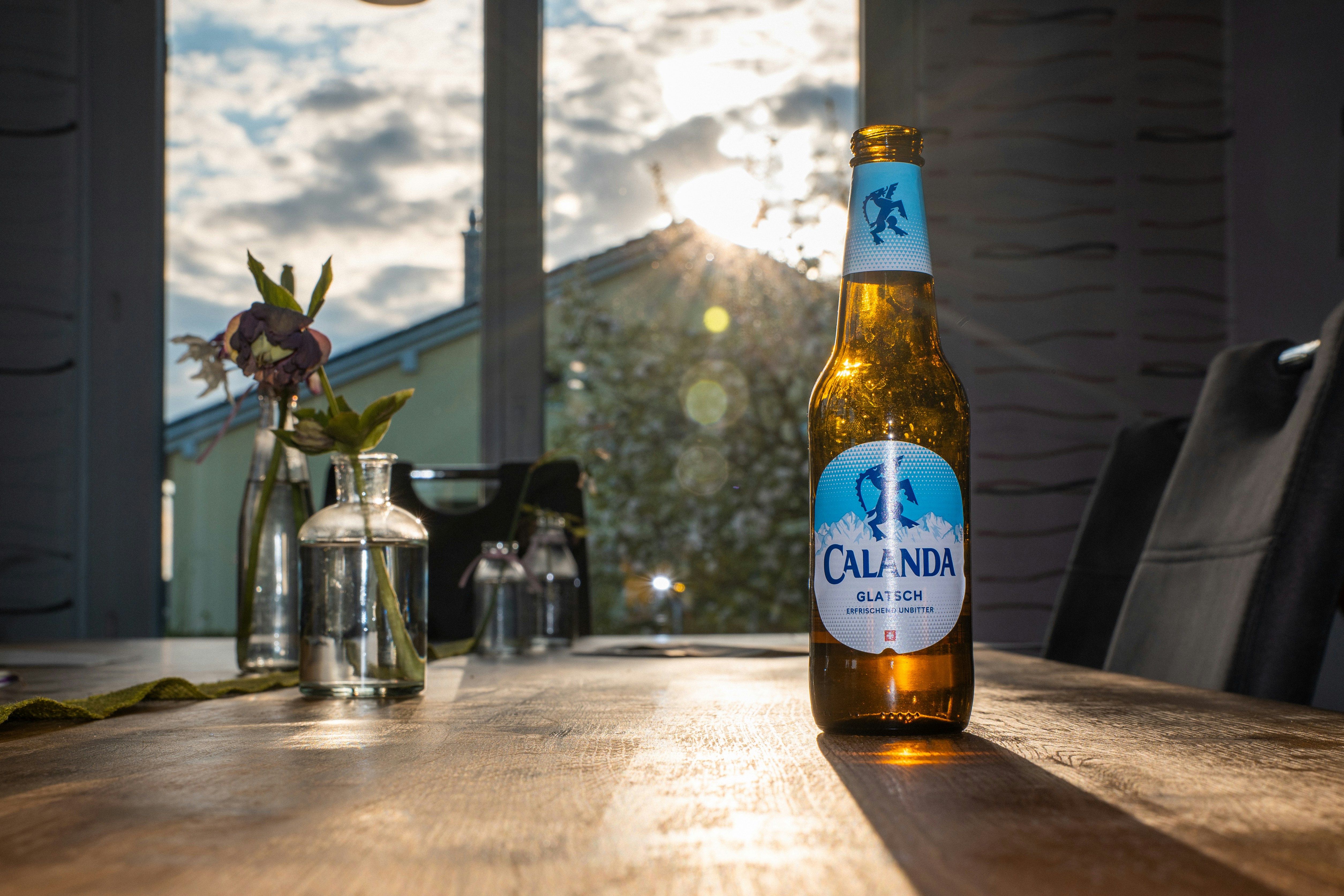 Sunlit Bottle on a Rustic Table at Golden Hour