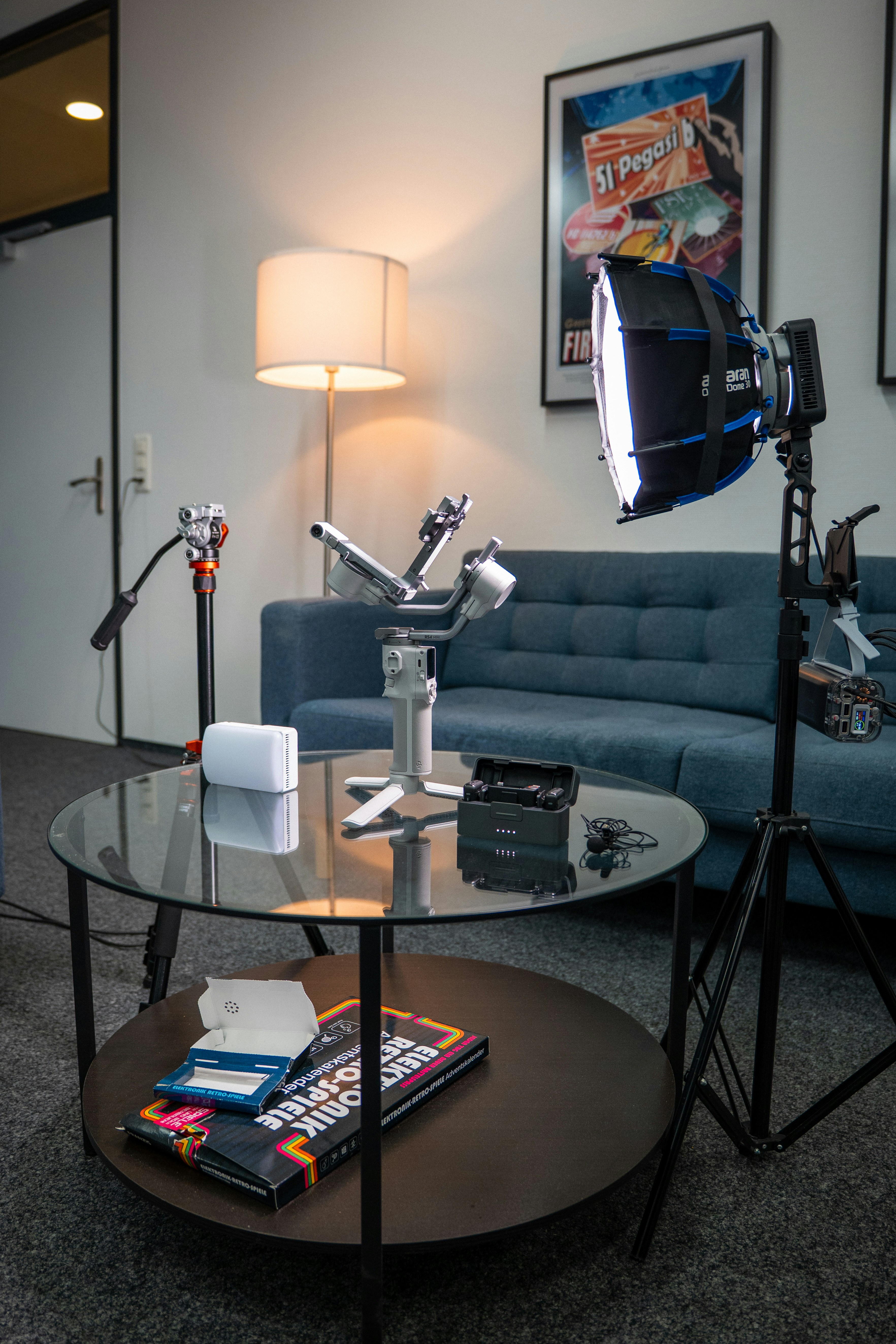 A studio setup with a gimbal, sofa, and professional lighting.