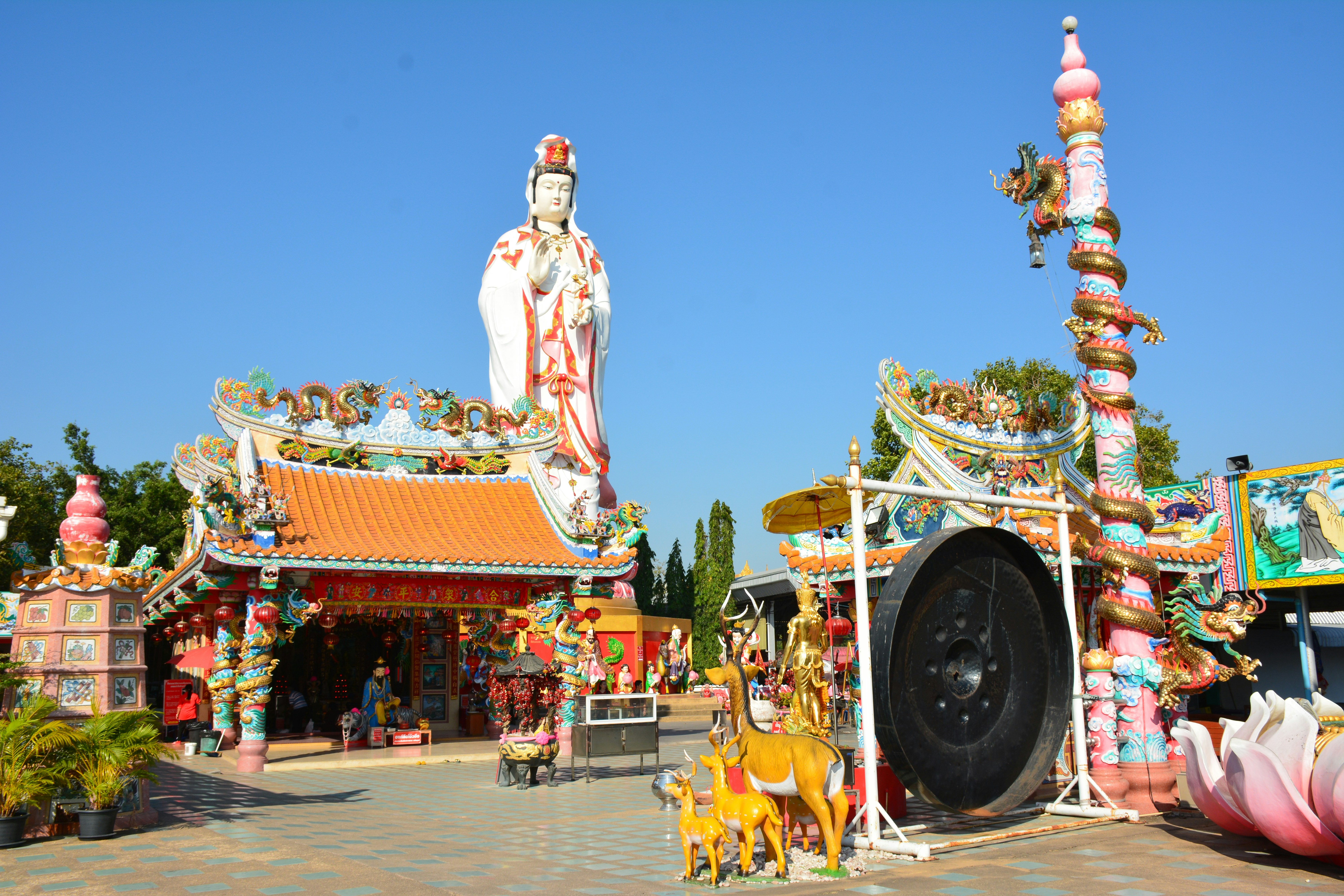 Colorful Temple Courtyard: Statues, Drum, and Dragon Columns