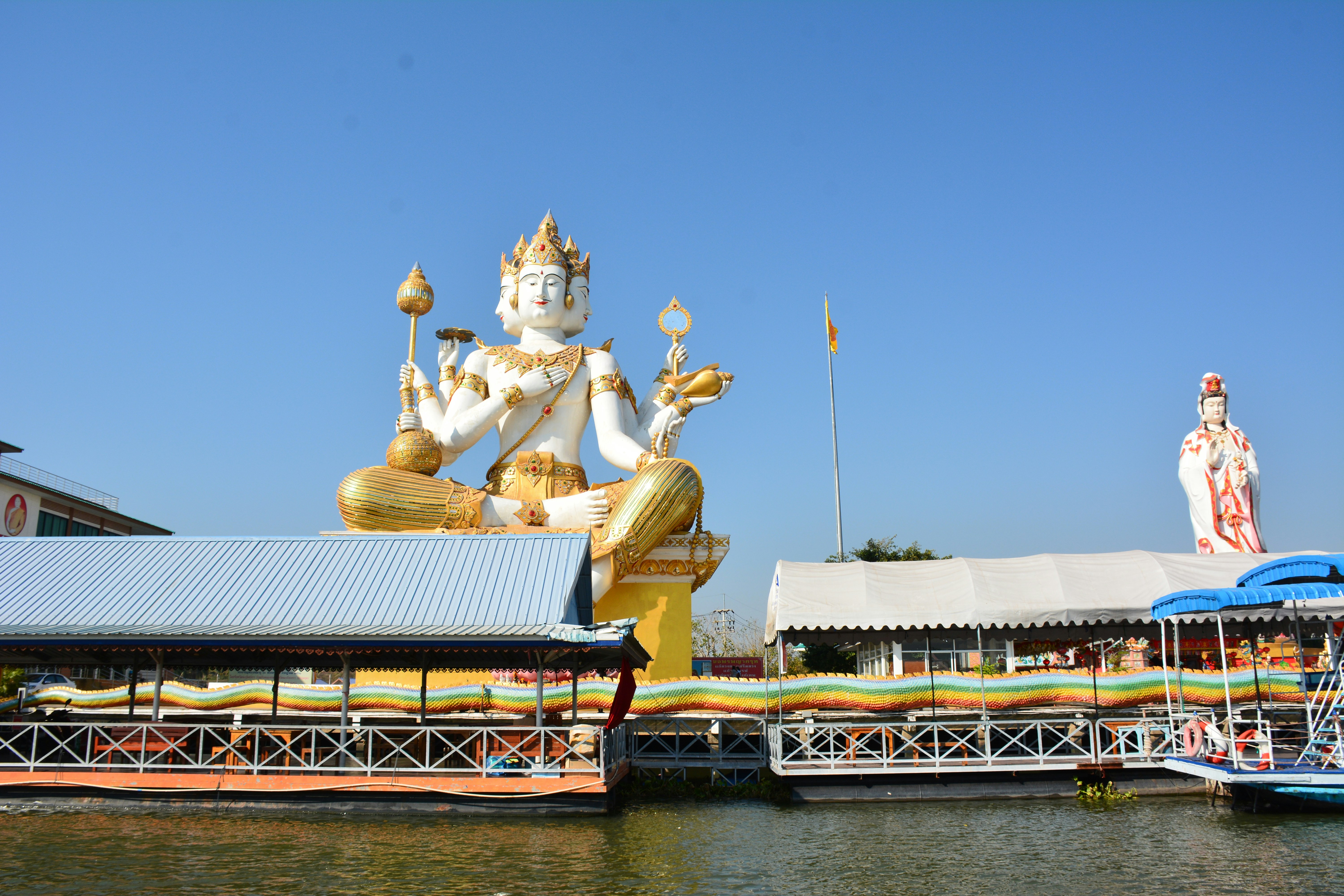 Golden Buddha Overlooking a Calm Waterfront Shrine