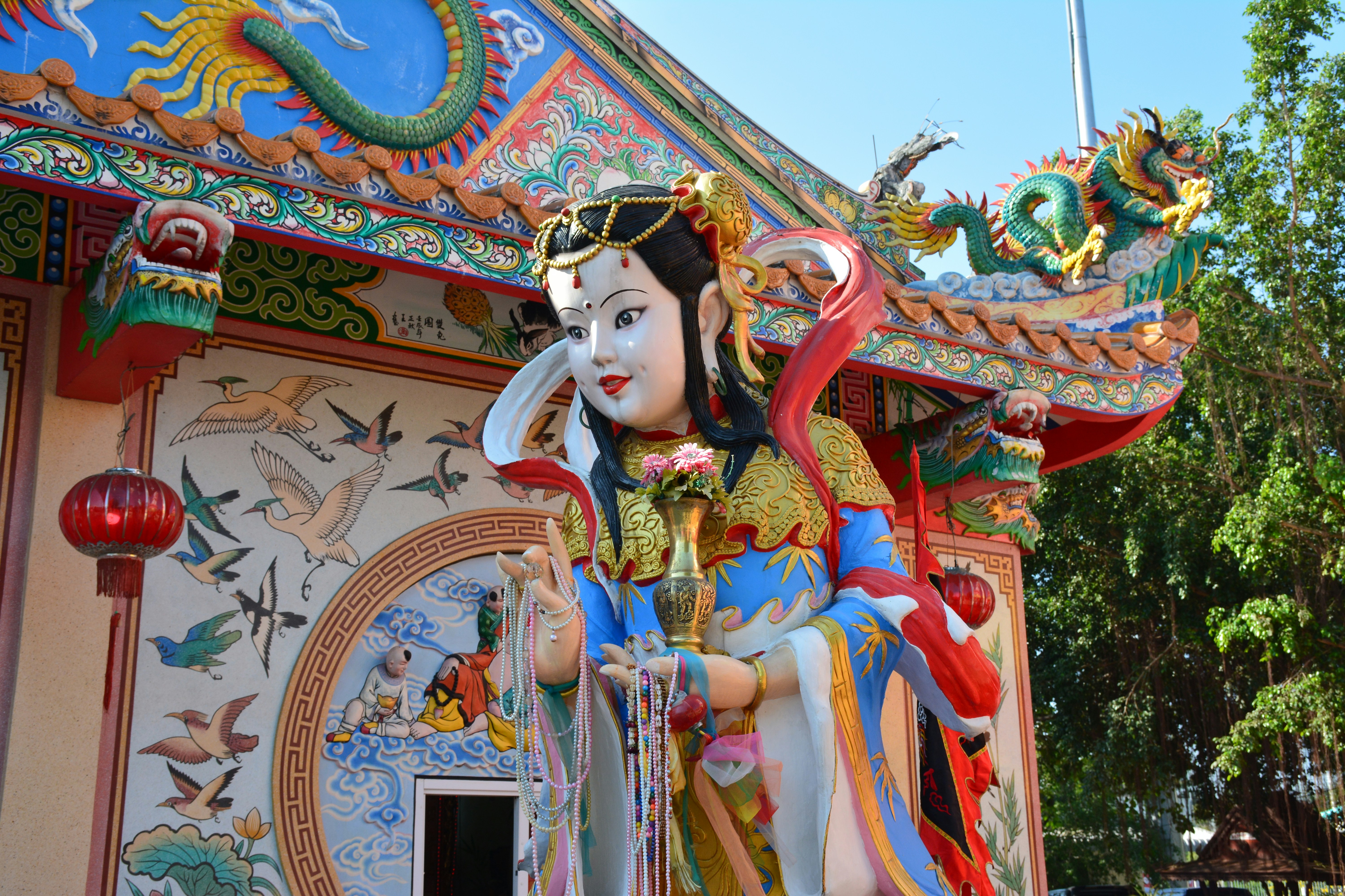 Temple Goddess in Colorful Shrine: A Stately Carving Amid Painted Backdrop