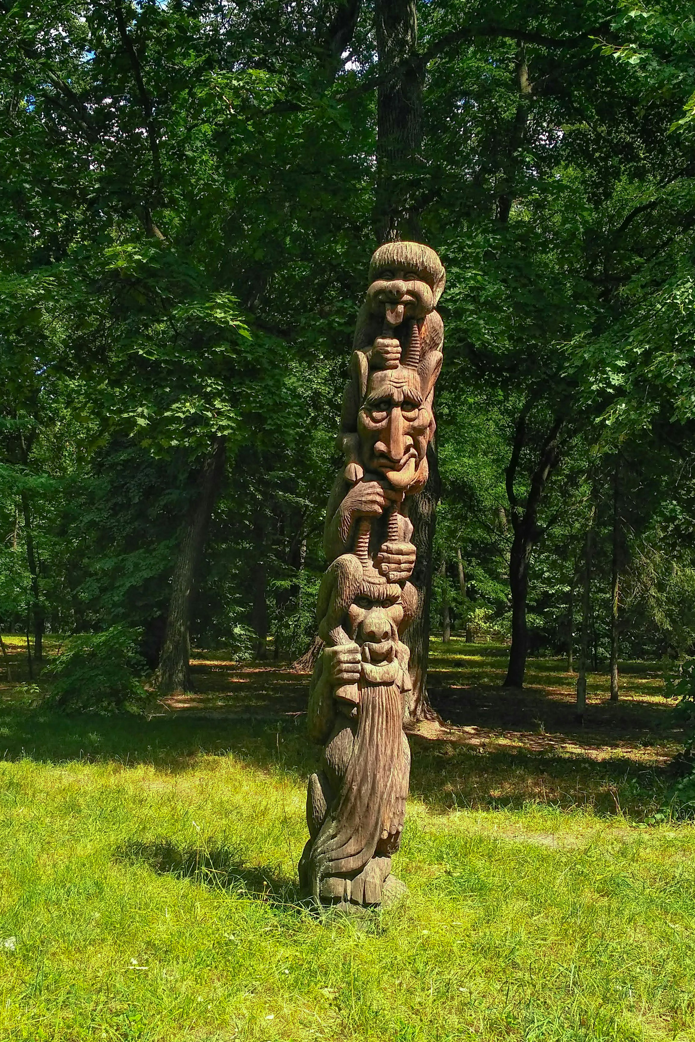 Whispering Totem: A Carved Ensemble Reaching Toward the Canopy