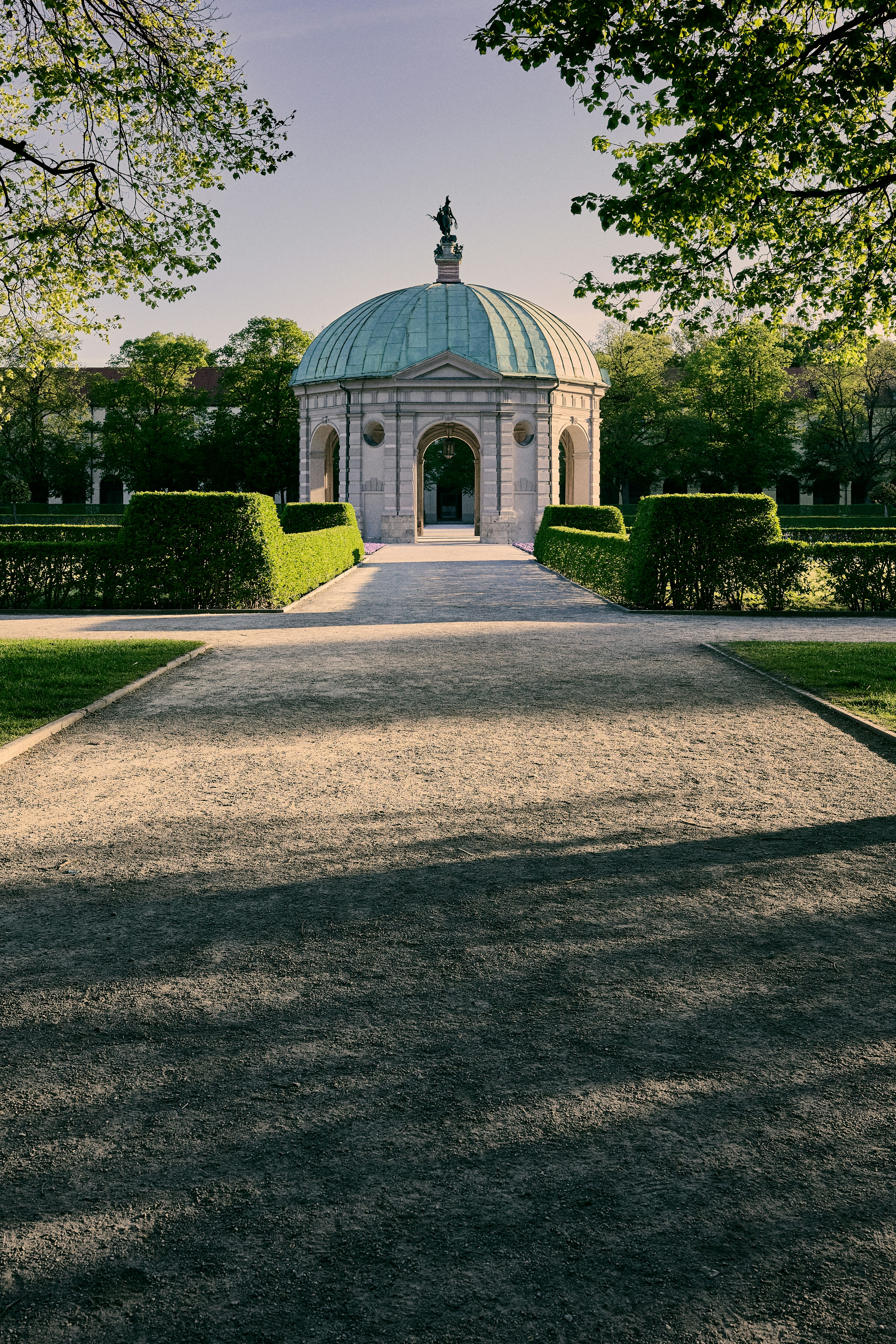 Domed classical pavilion at the end of a park path