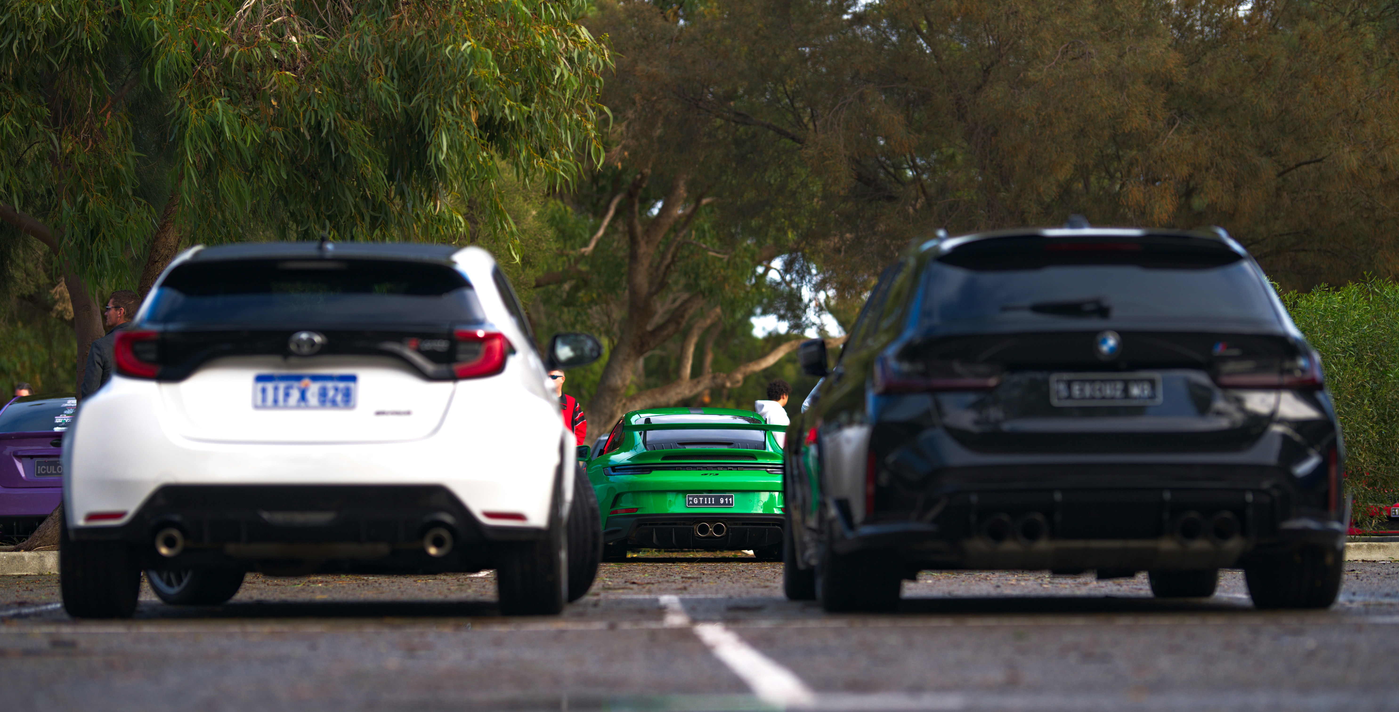Green Courage in the Parking Lane: A Tiny Sports Car Between Titans