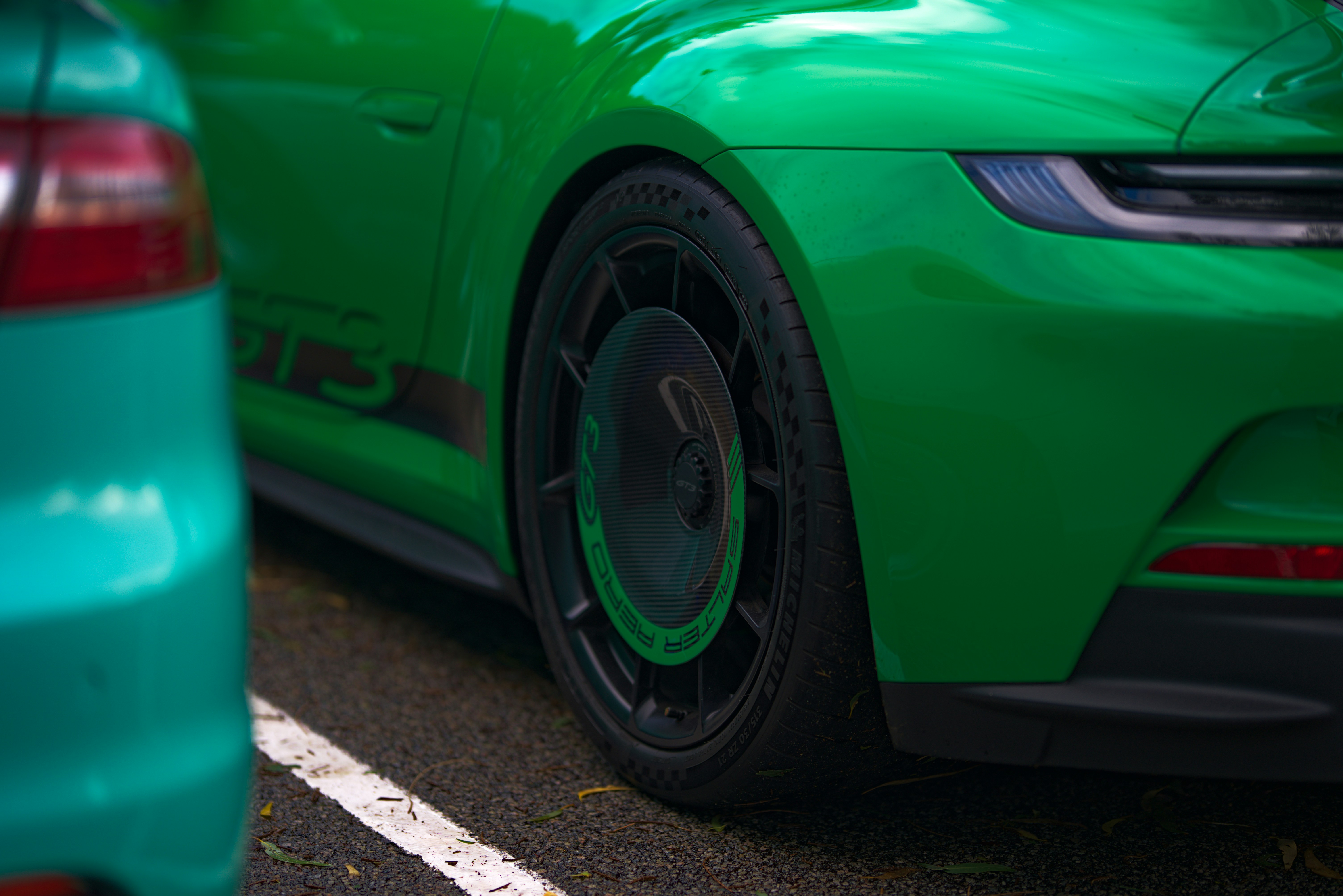 Green Thoroughbred: A Close-Up of the Porsche-Tuned Wheel in Motion