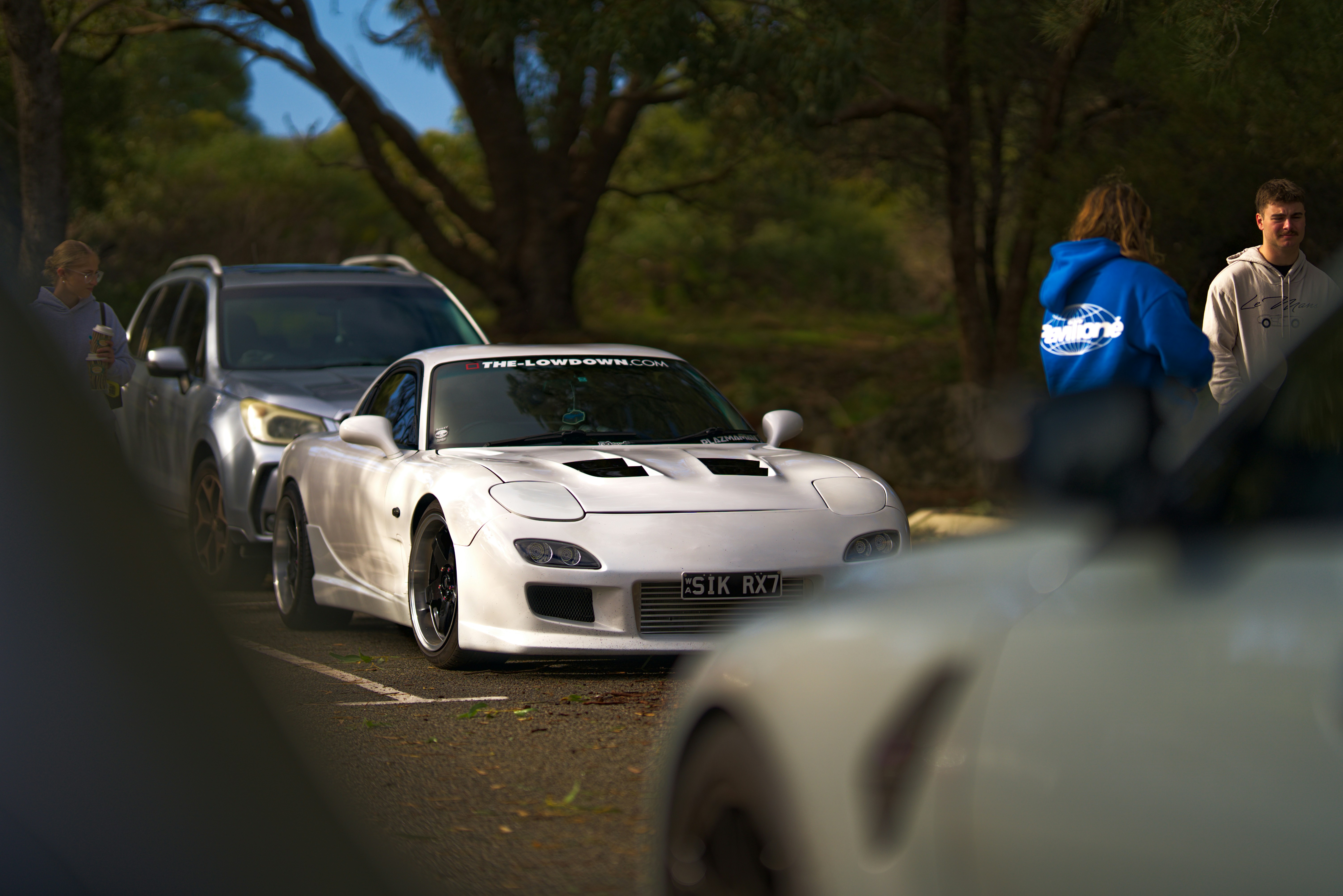 White Mazda RX-7 Crowned by the Parked Row
