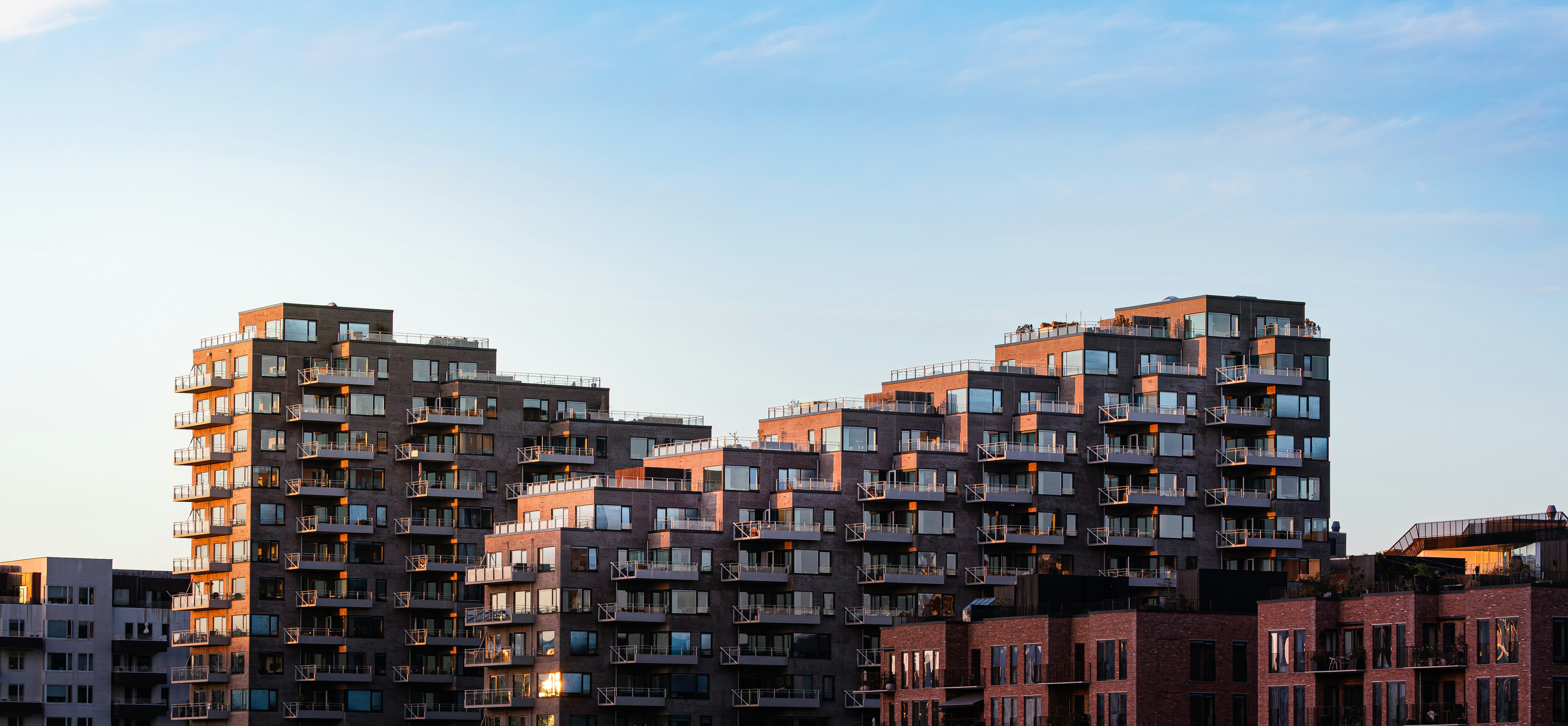 Modern apartment buildings with balconies under a clear blue sky. photo ...