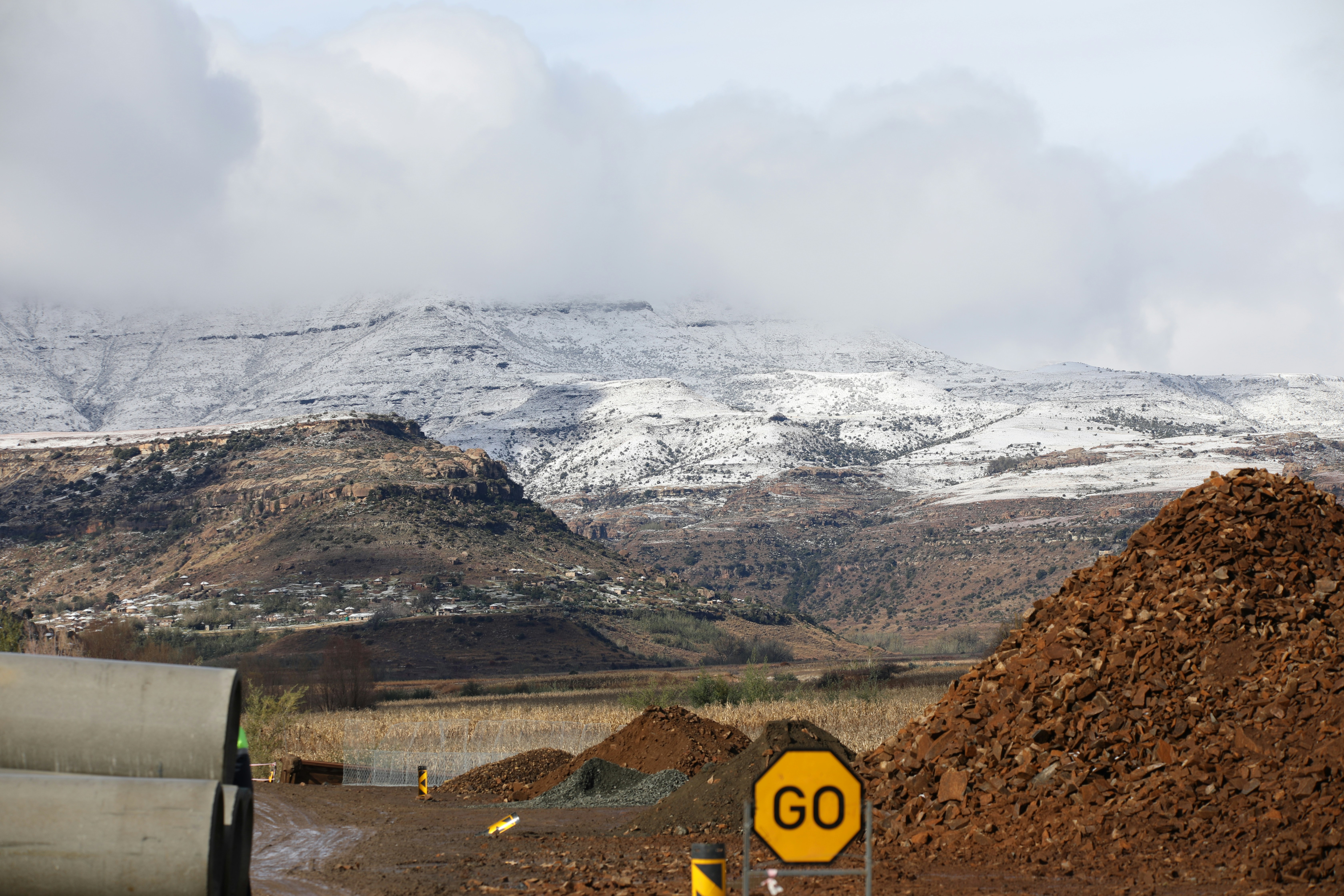 Desert Construction at Distant Snow-Trimmed Ridge