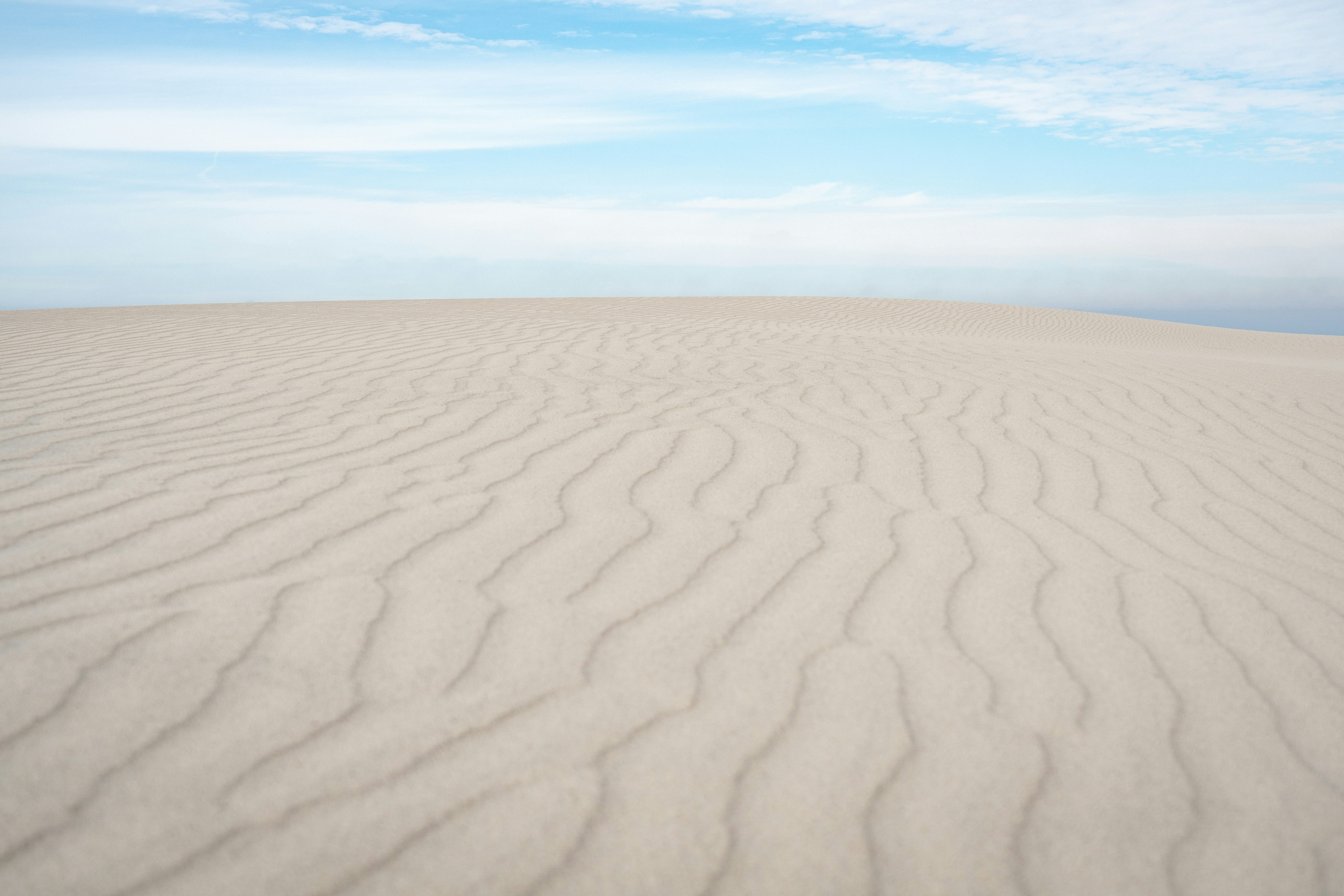Whispering Ridges: Wind-Carved Sands Under a Wide Sky