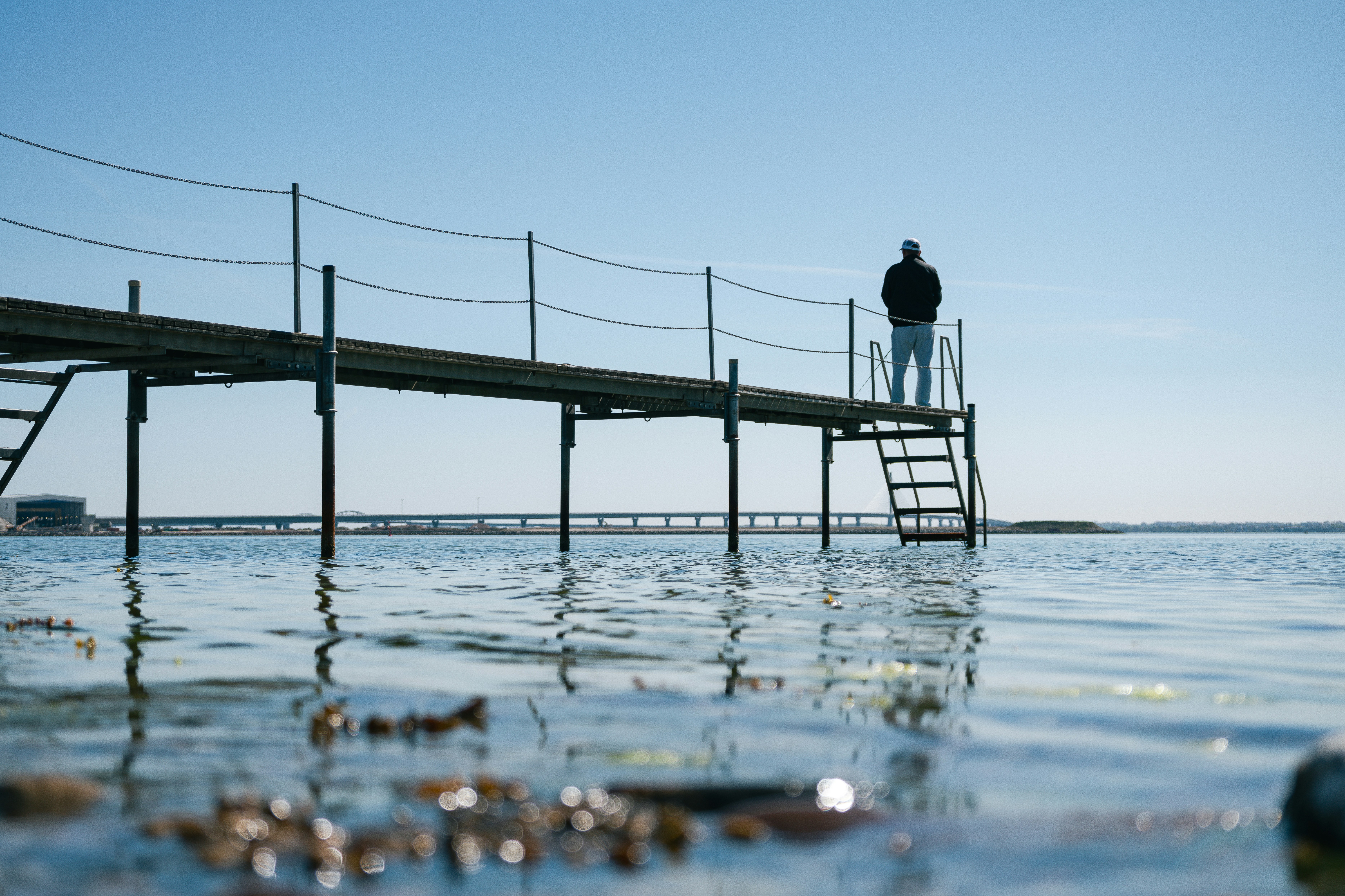 Lone Observer on a Sea-Wavored Pier