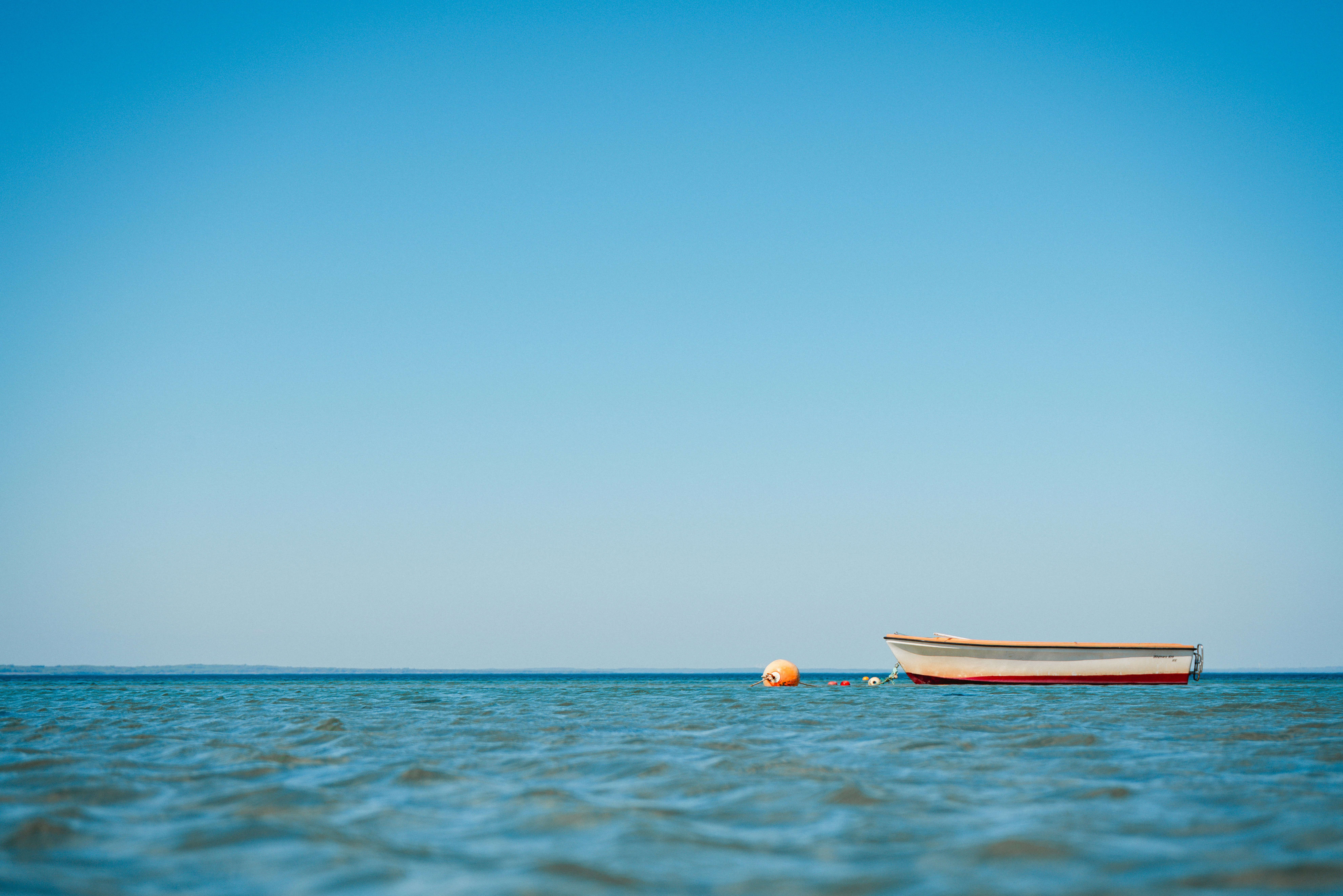 Quiet Horizon: A Boat at Rest on a Calm Sea