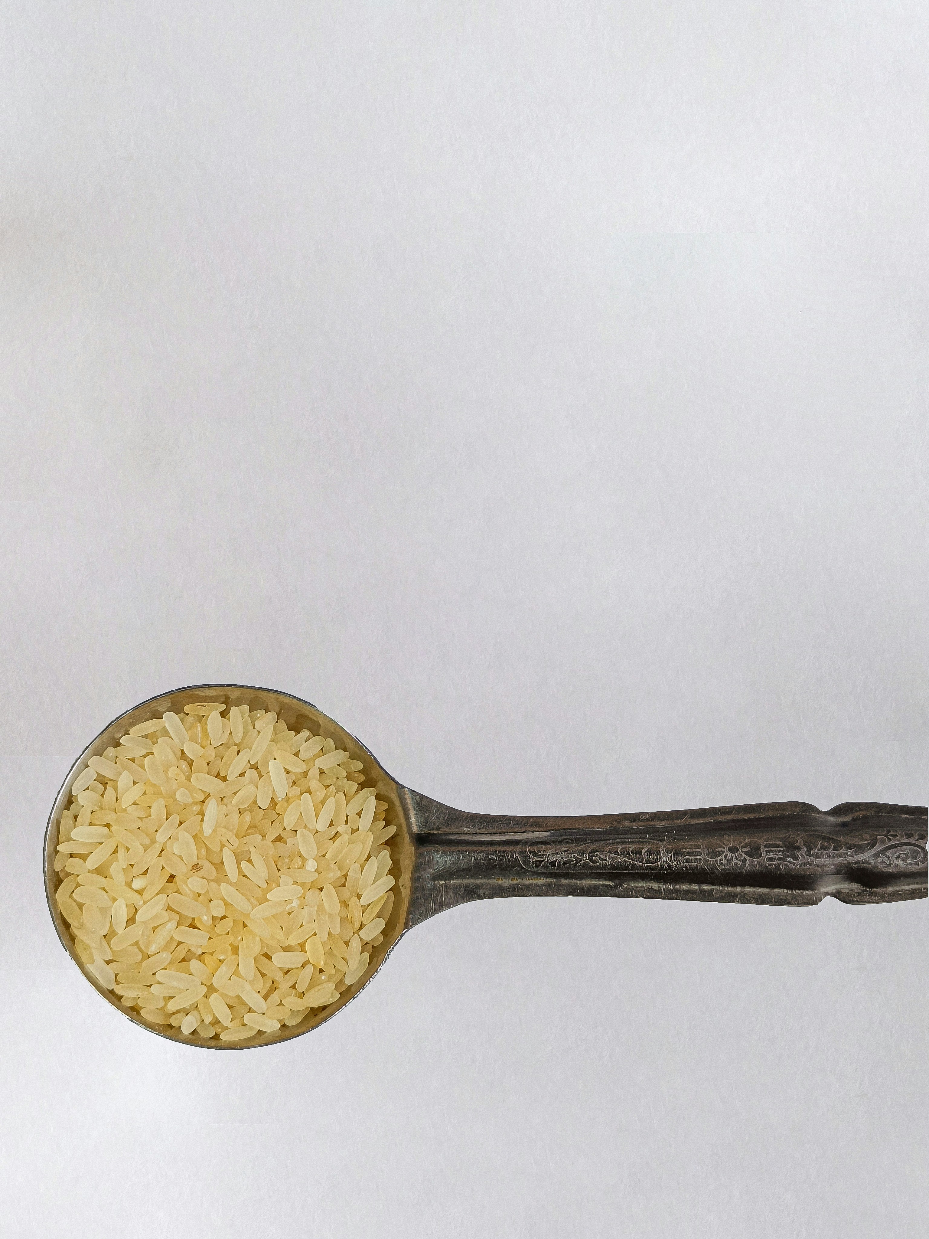Spoonful of Rice: Minimalist Still-Life with a Weathered Handle