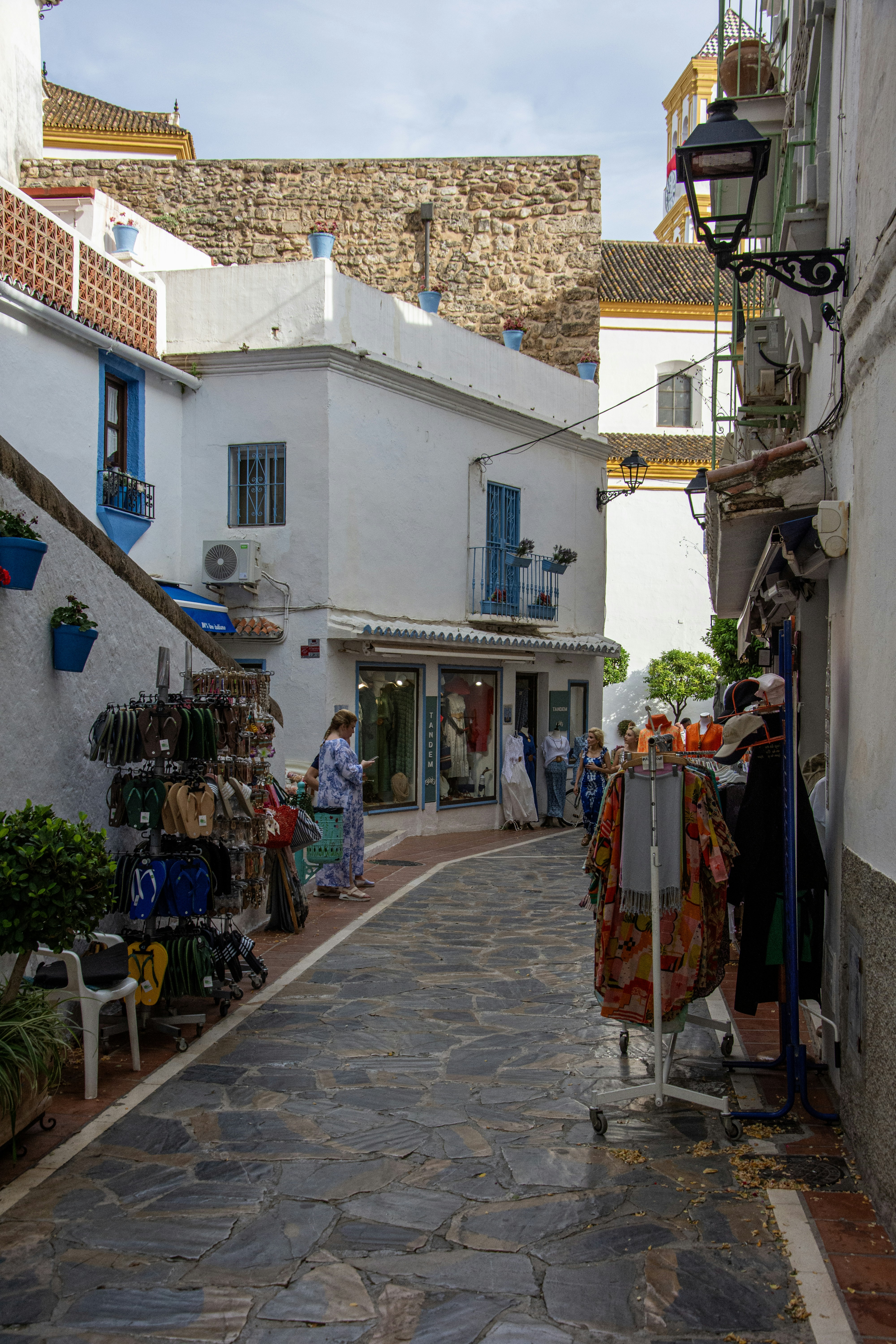 Quiet Calle of Whitewashed Shops and Colorful Market Stall