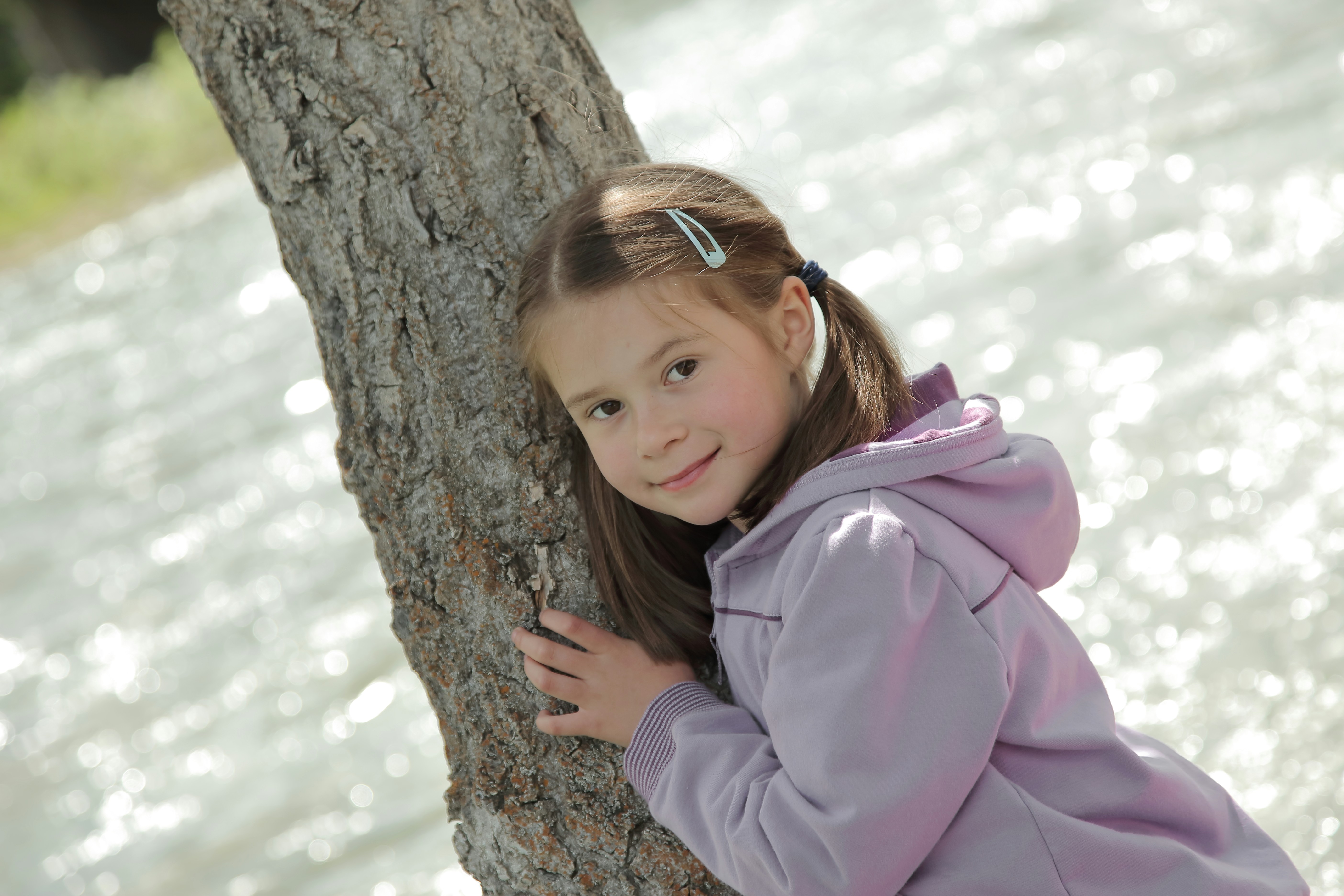 Youthful Curiosity Anchored to a Tree by the Water