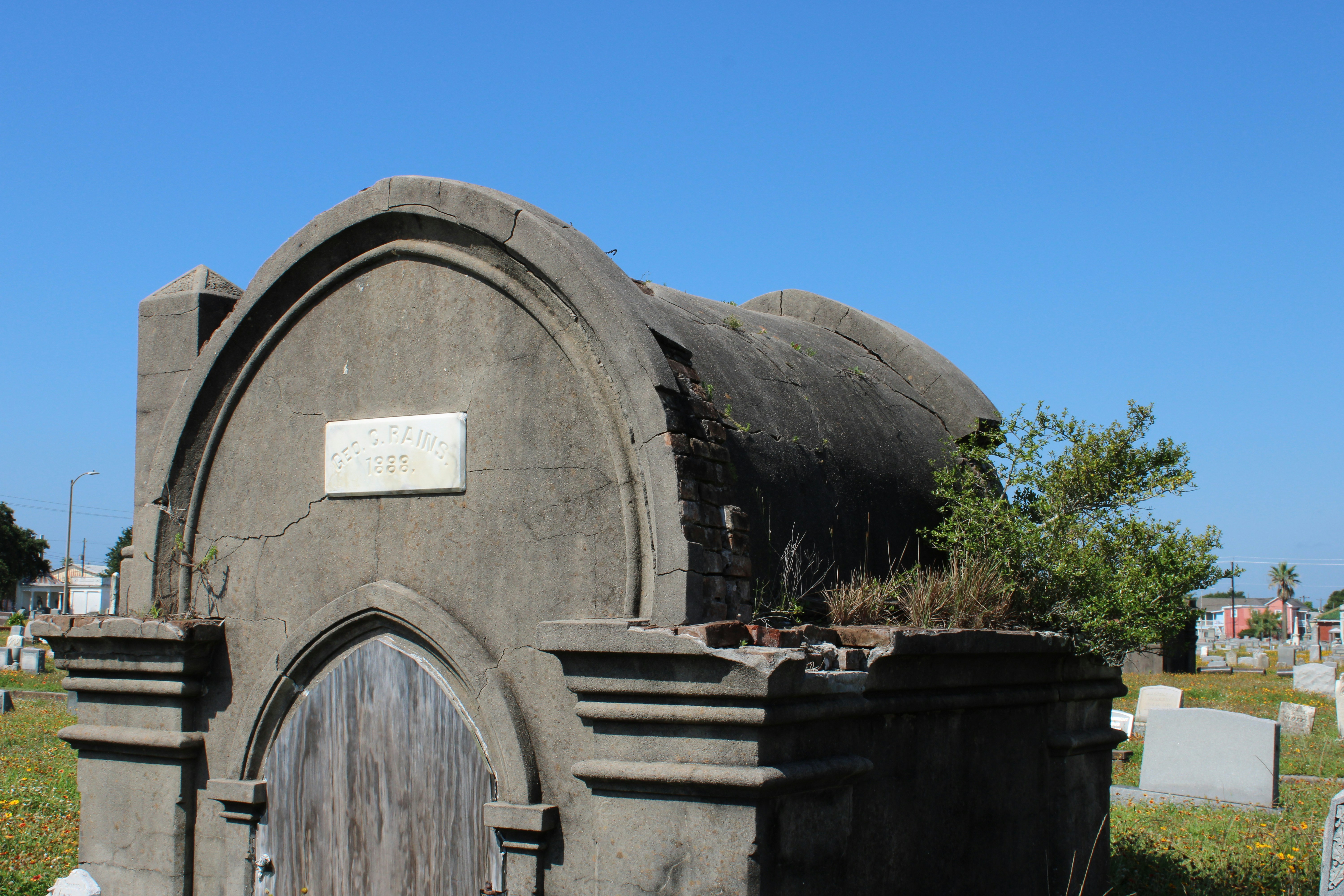 Weathered Mausoleum Arches Under a Clear Blue Sky