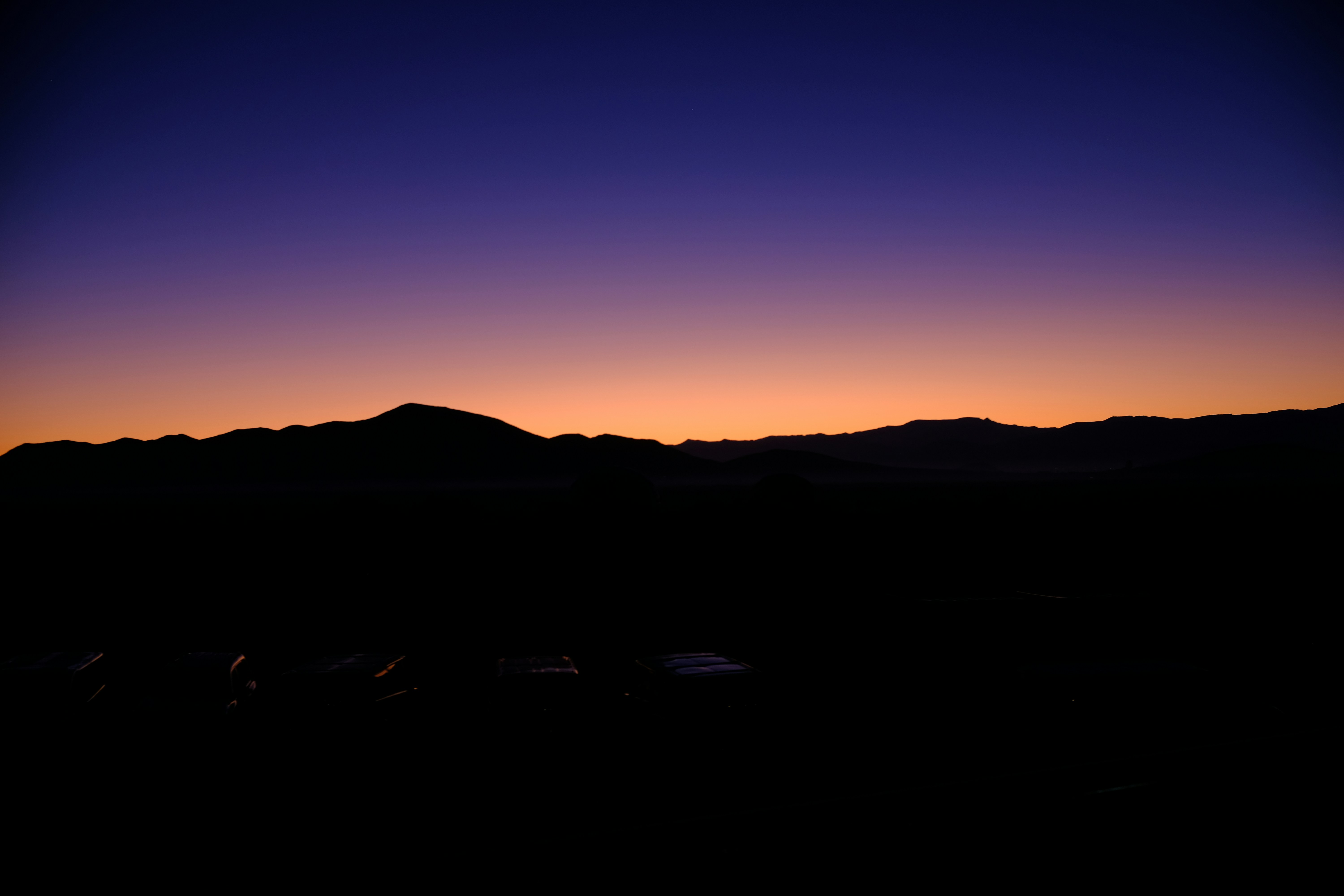 Silent Horizon: Twilight silhouettes over a backlit ridge