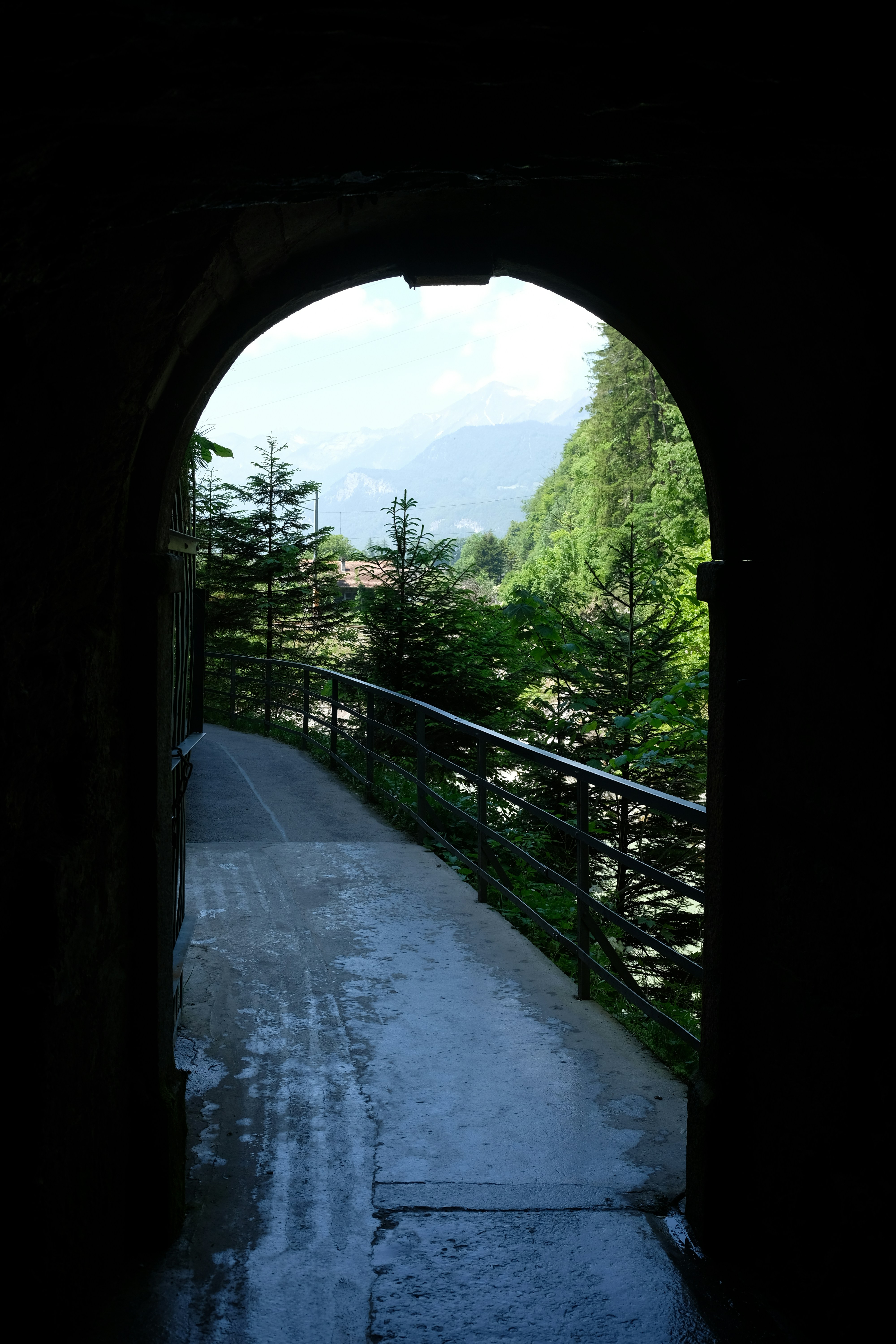 Light at the Tunnel’s End: Mountain View Through a Narrow Arch