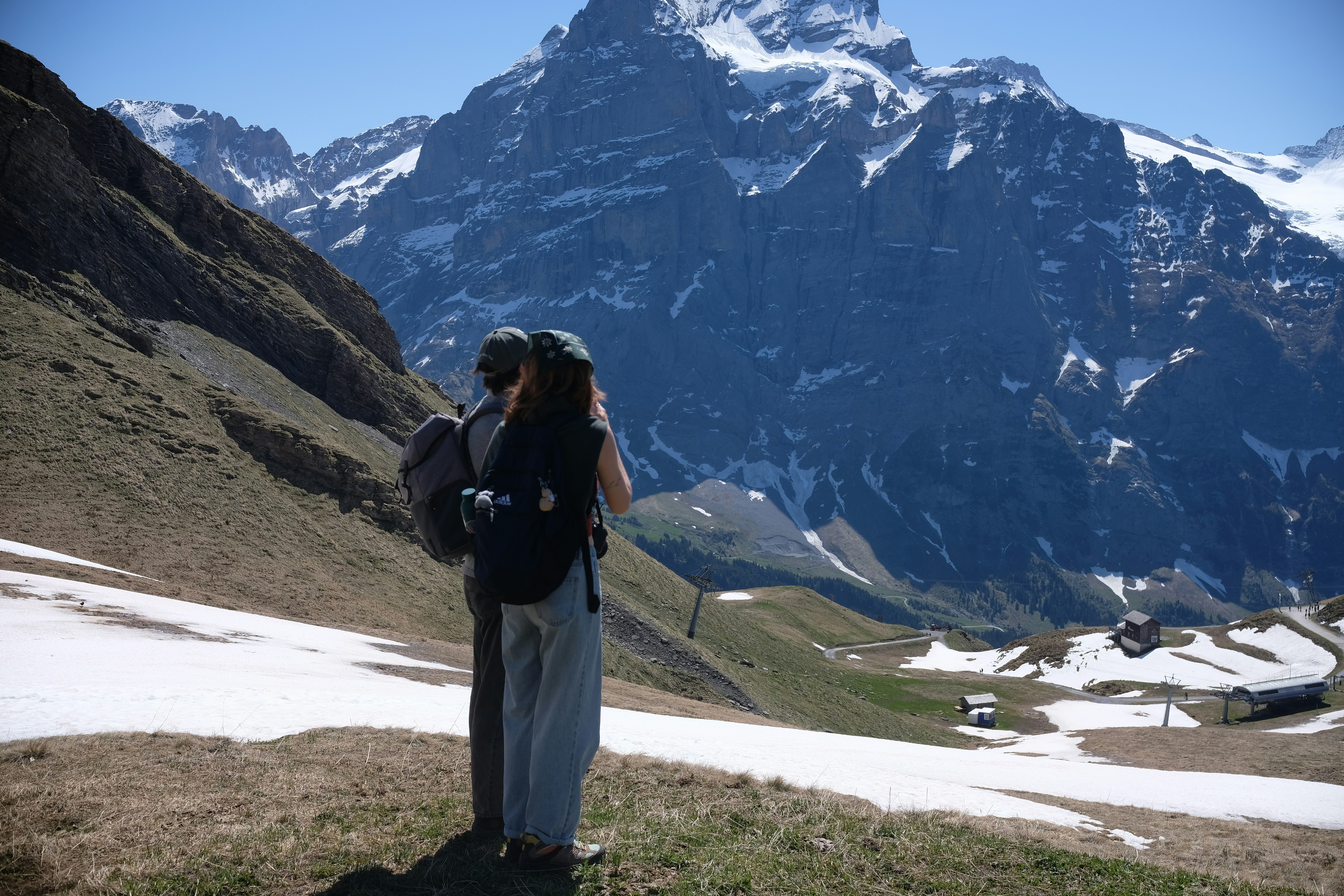 Couple Embraces with Snow-dusted Peaks