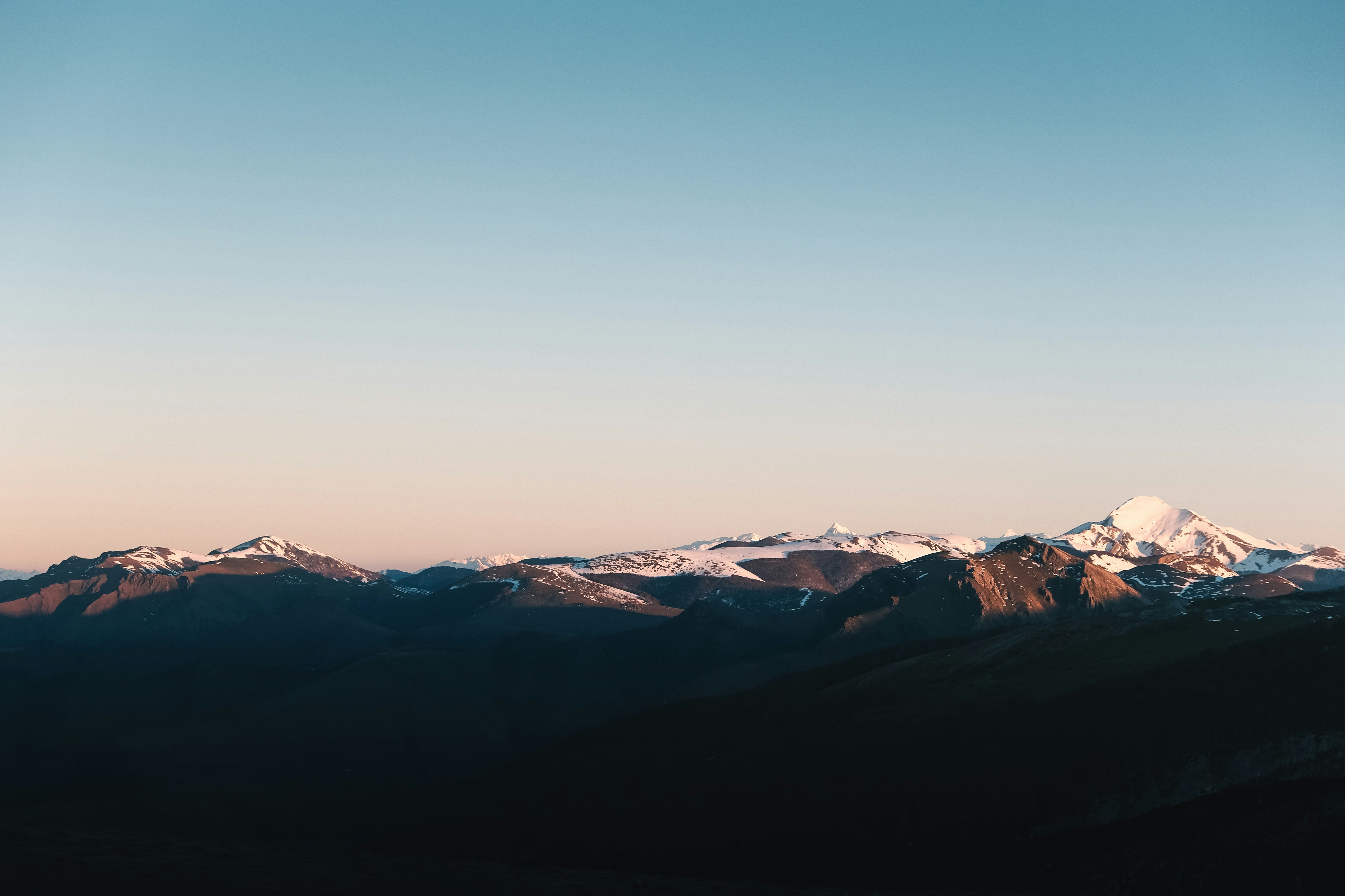 First Light on the Snow-Capped Ridge