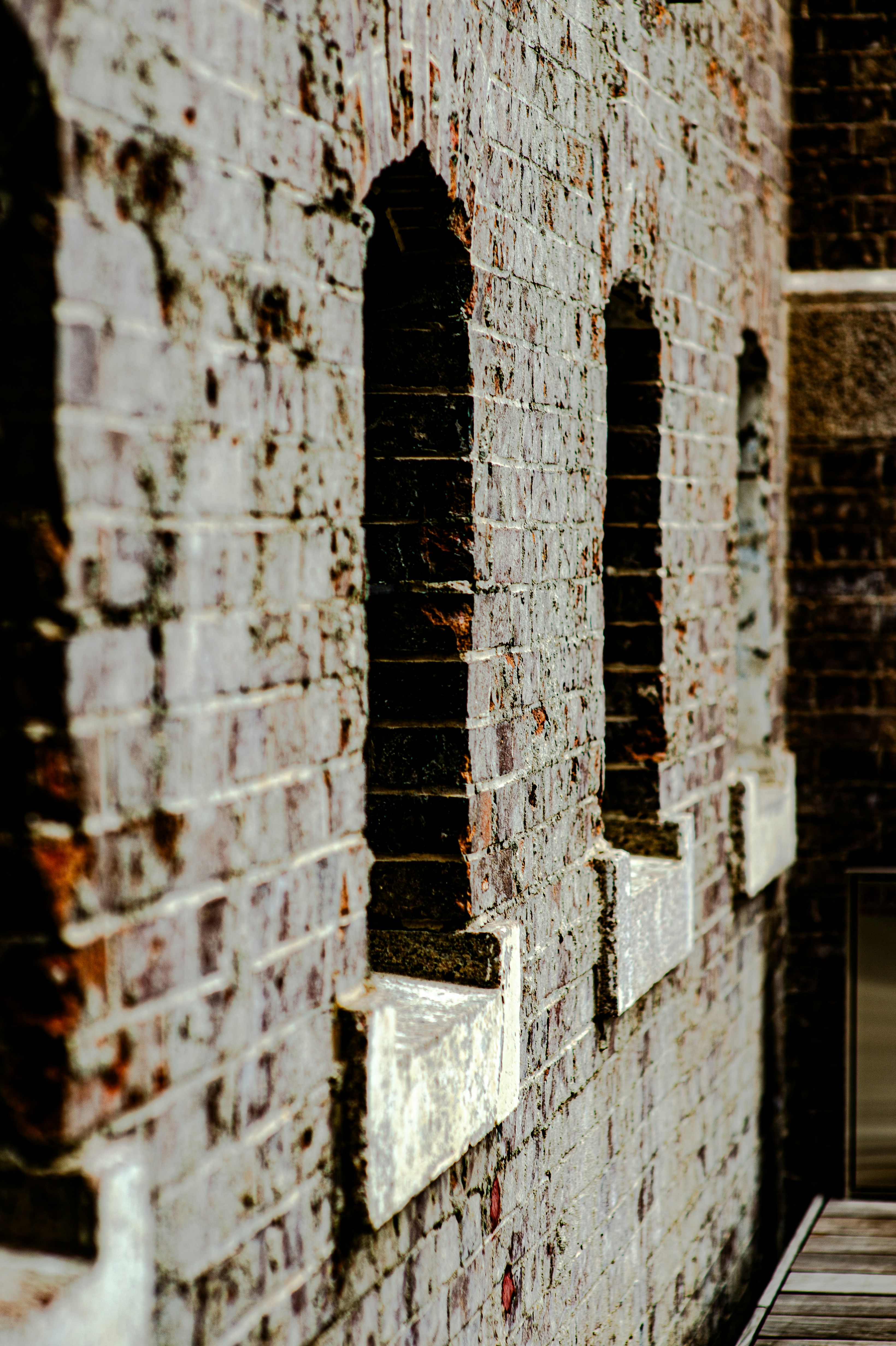Industrial Dented Light: Weathered Brick Arches in a Quiet Alley