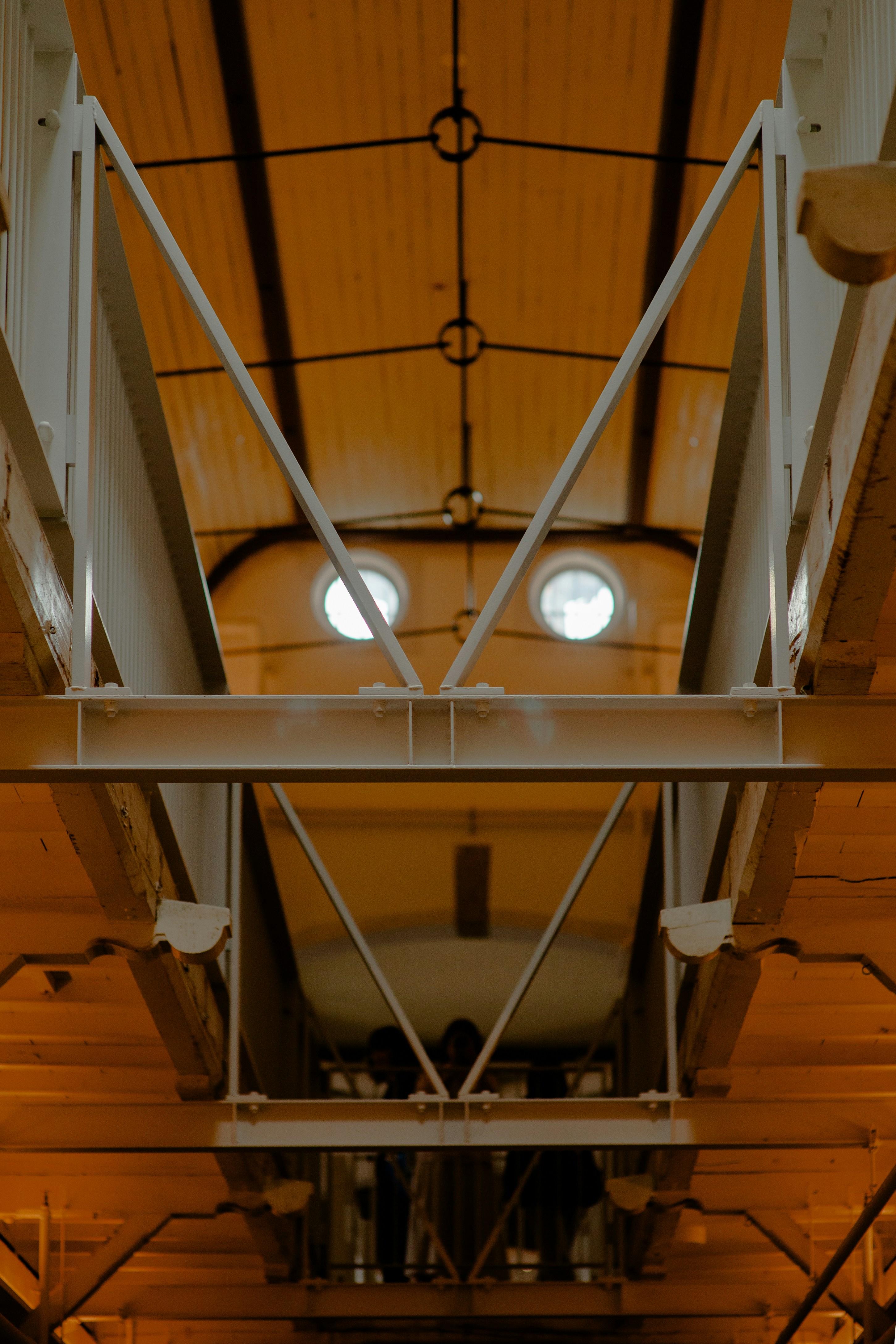 Crossed Steel Ribs in a Warm Cathedral of Wood