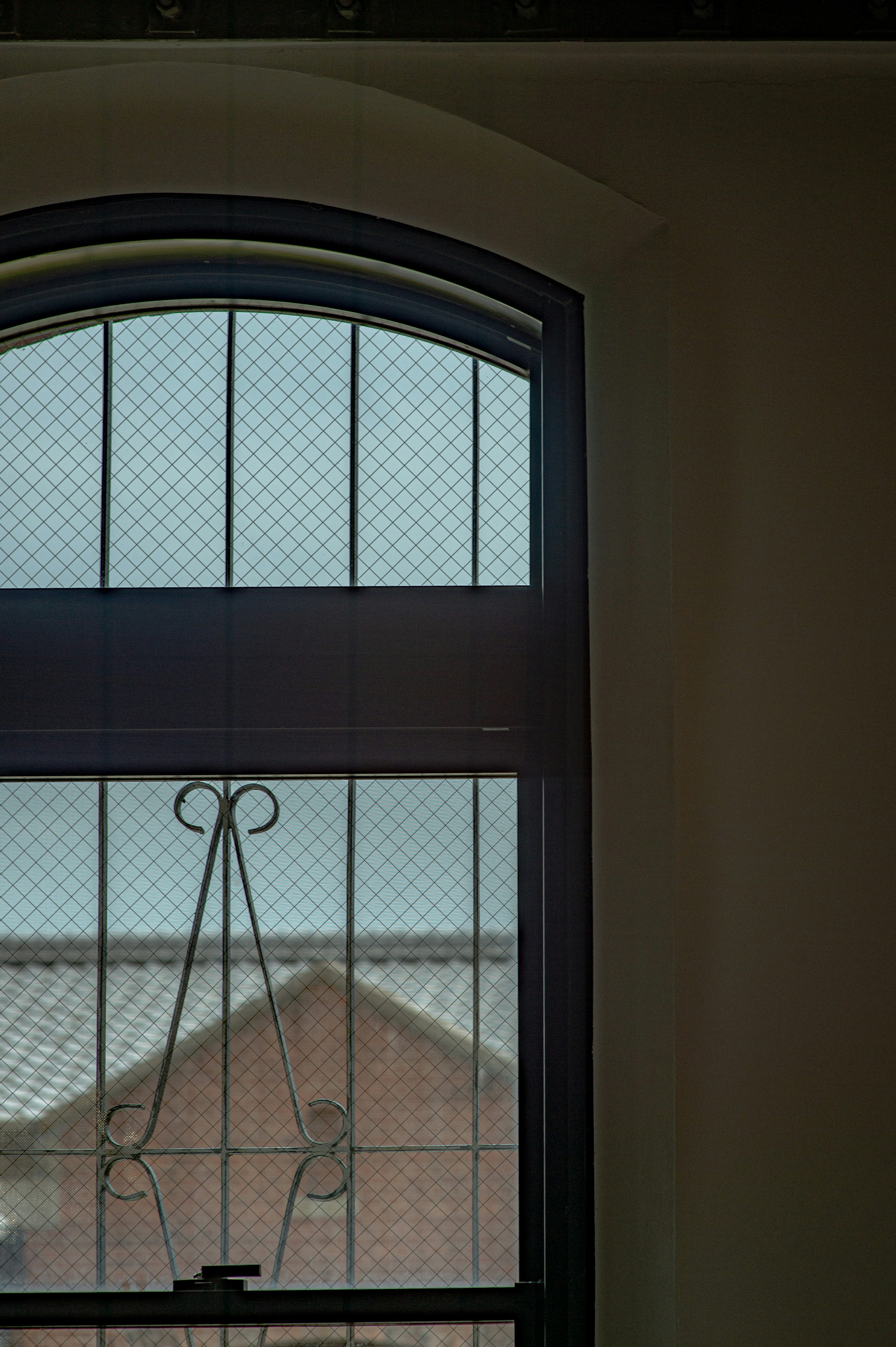 Arched Window with Gridded Metalwork and Soft Backlight