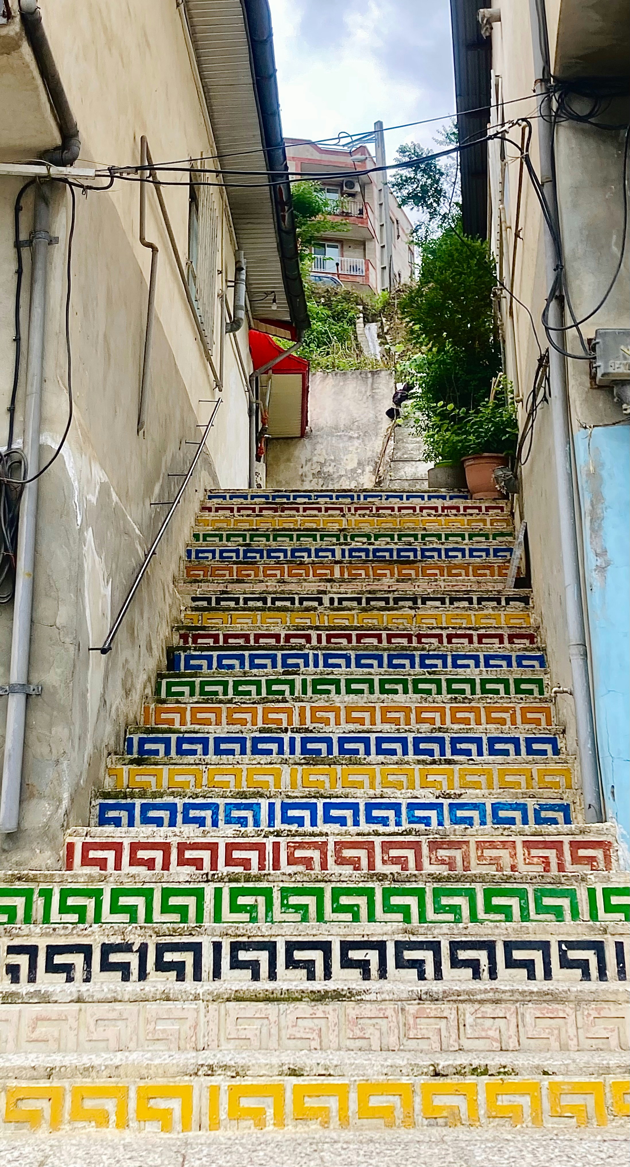 Colorful Staircase Through a Narrow Urban Canyon