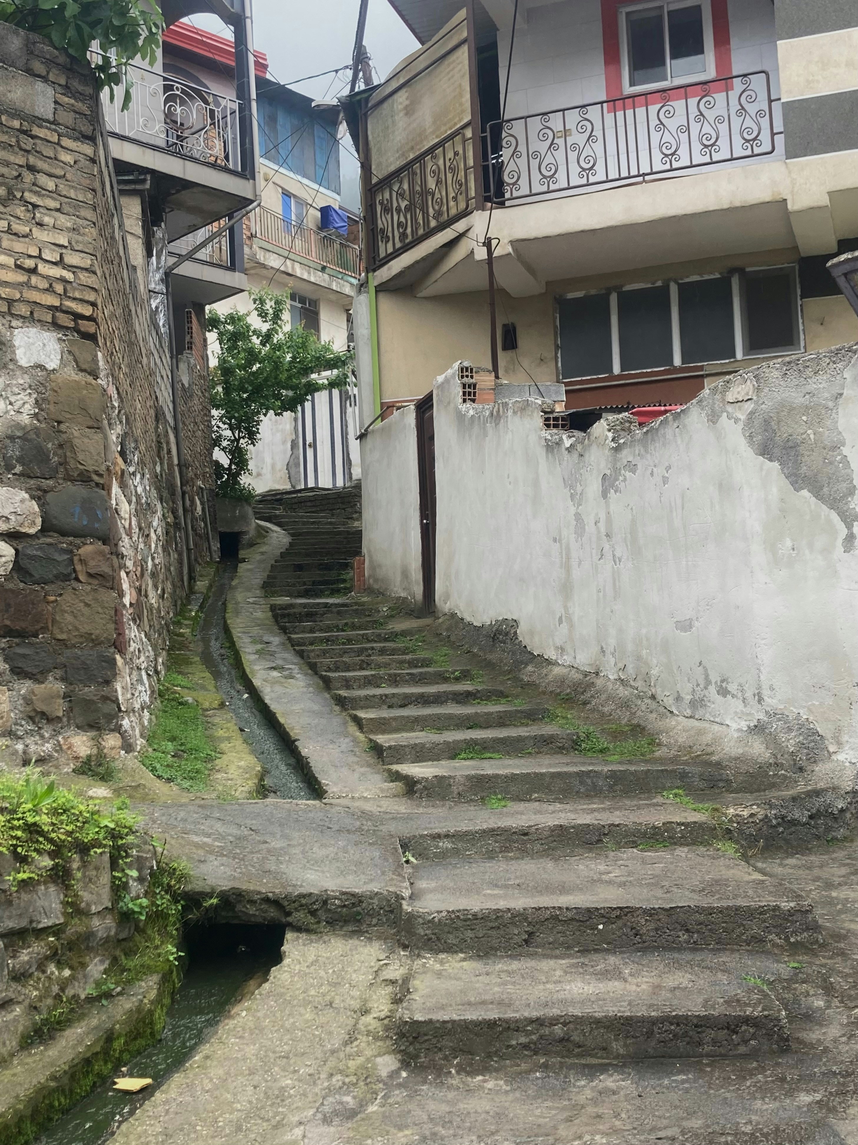 Winding stairway between sunlit terraces