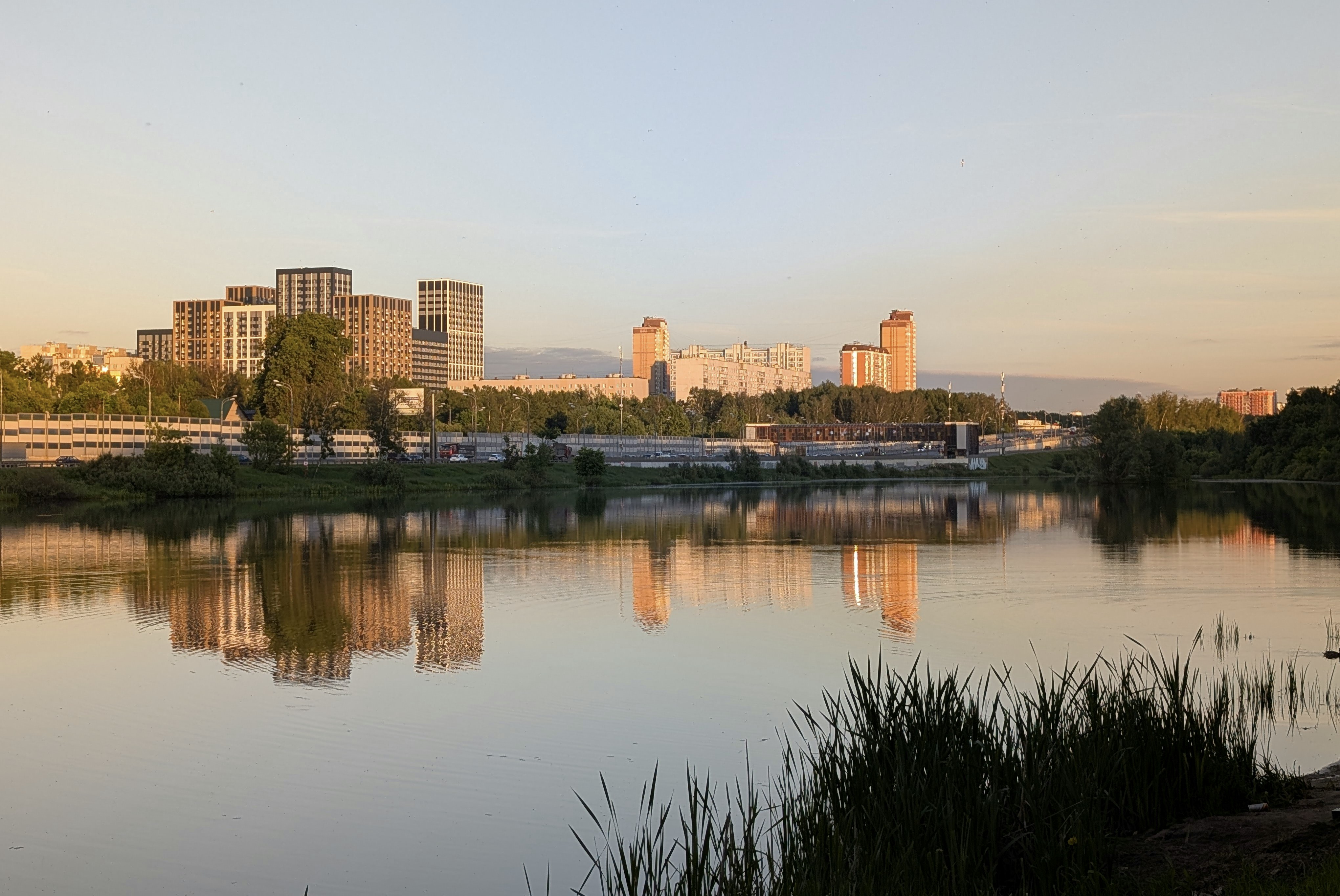 Sunlit Riverside Skyline Reflections at Dusk