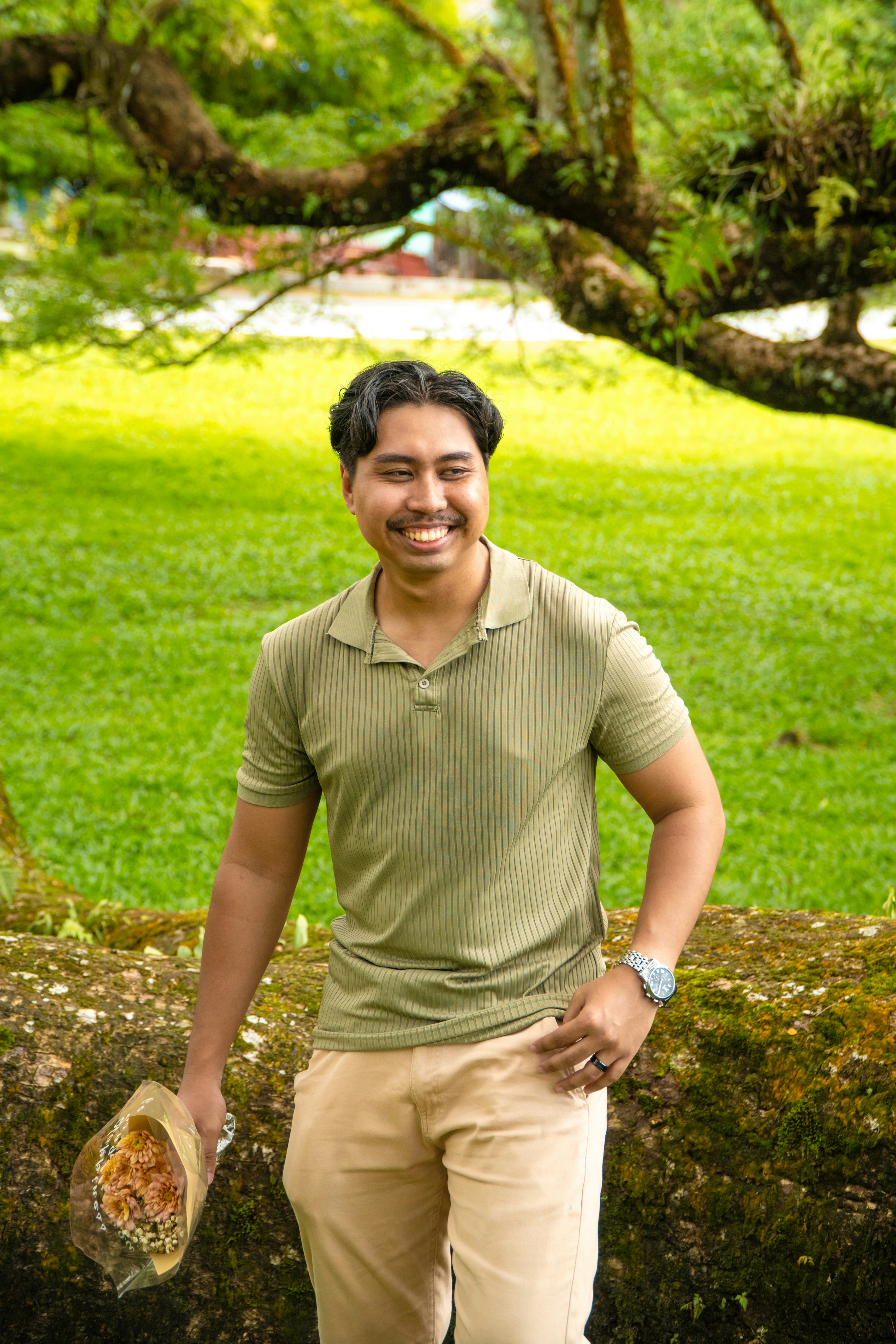 Smiling in the Shade: A Moment Beneath the Branches