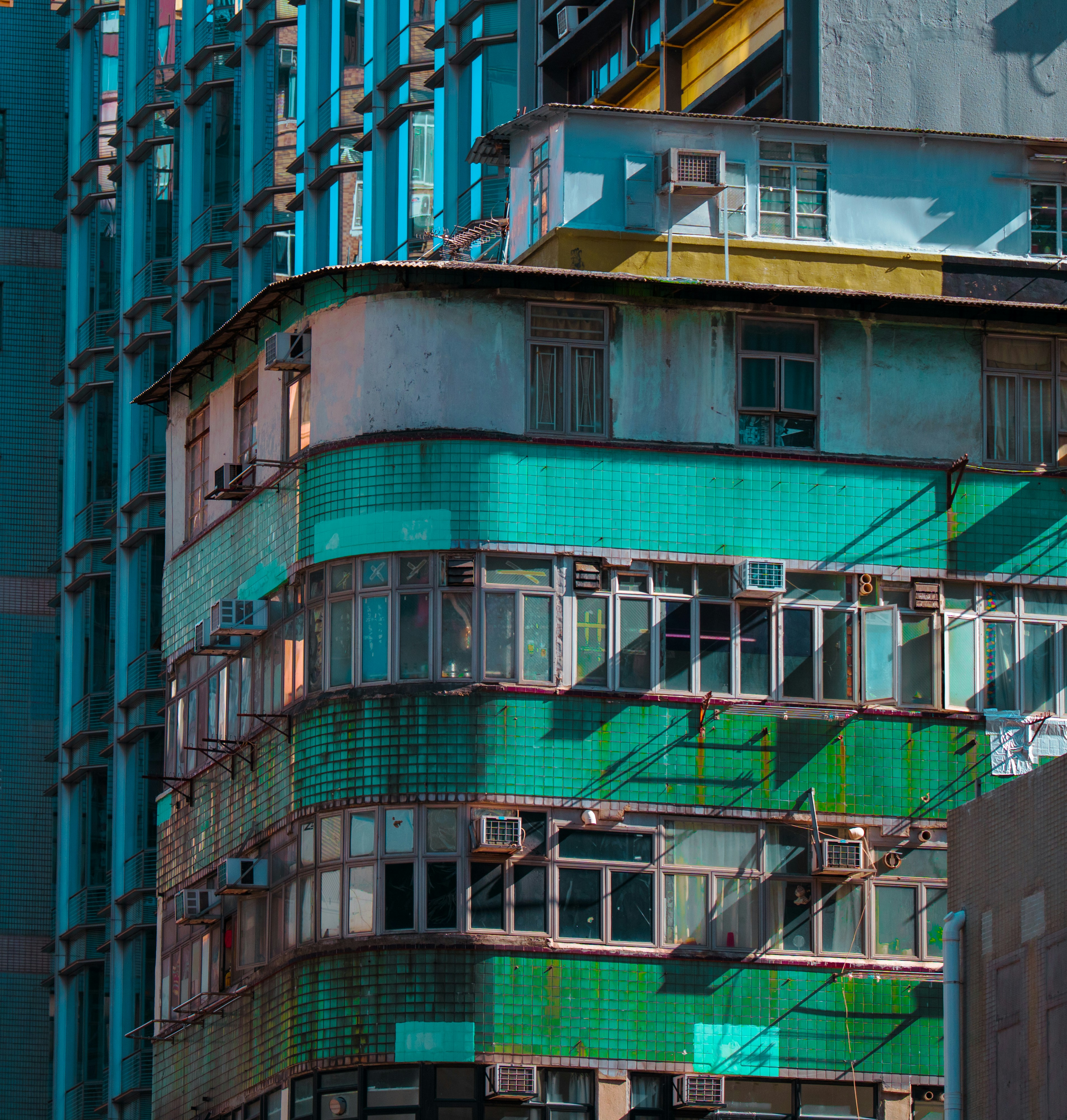 Emerald Facade: A Segmented Street of Tiles and Windows