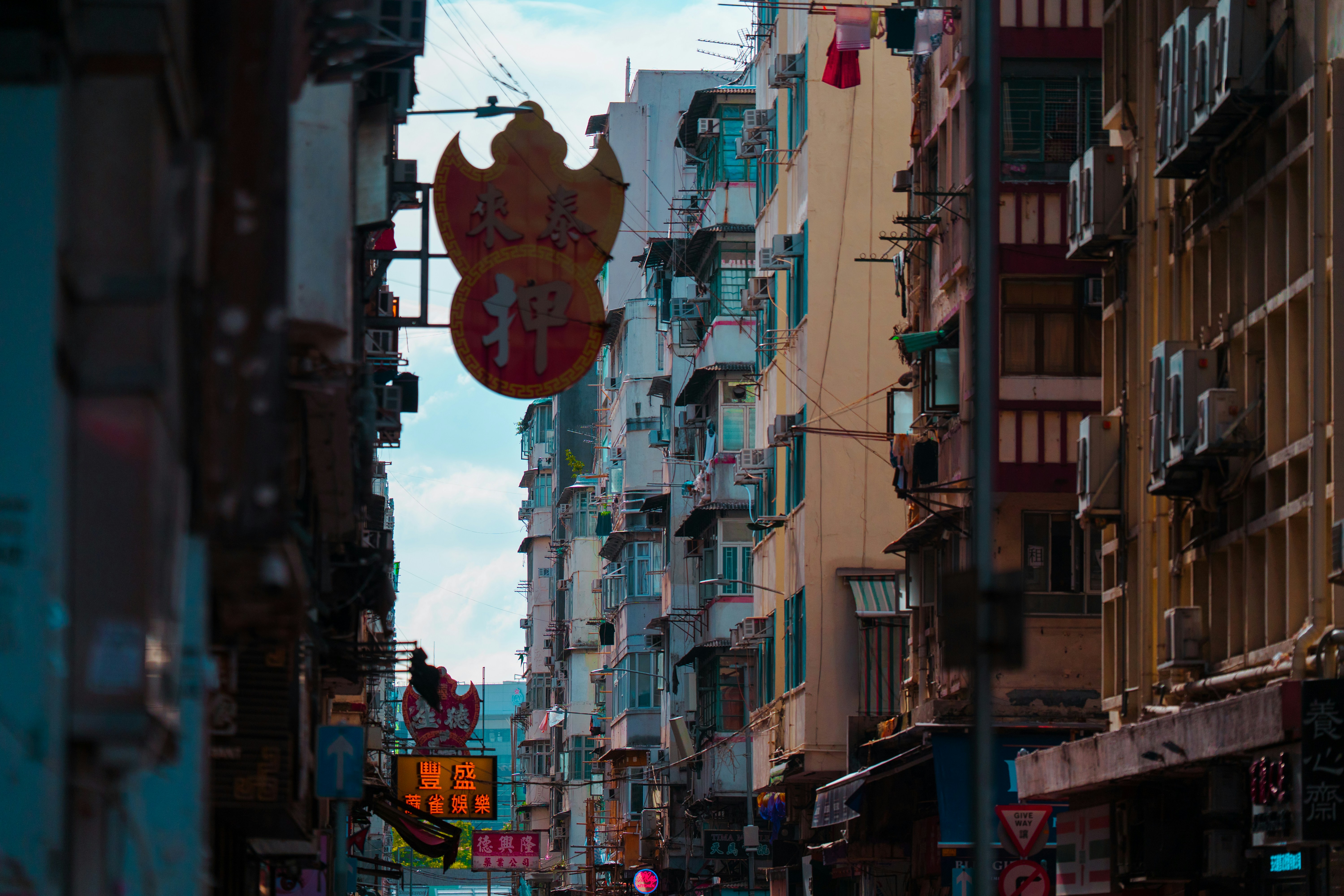 Neon Alleyways: Signage and Towers Framing a Distant Sky