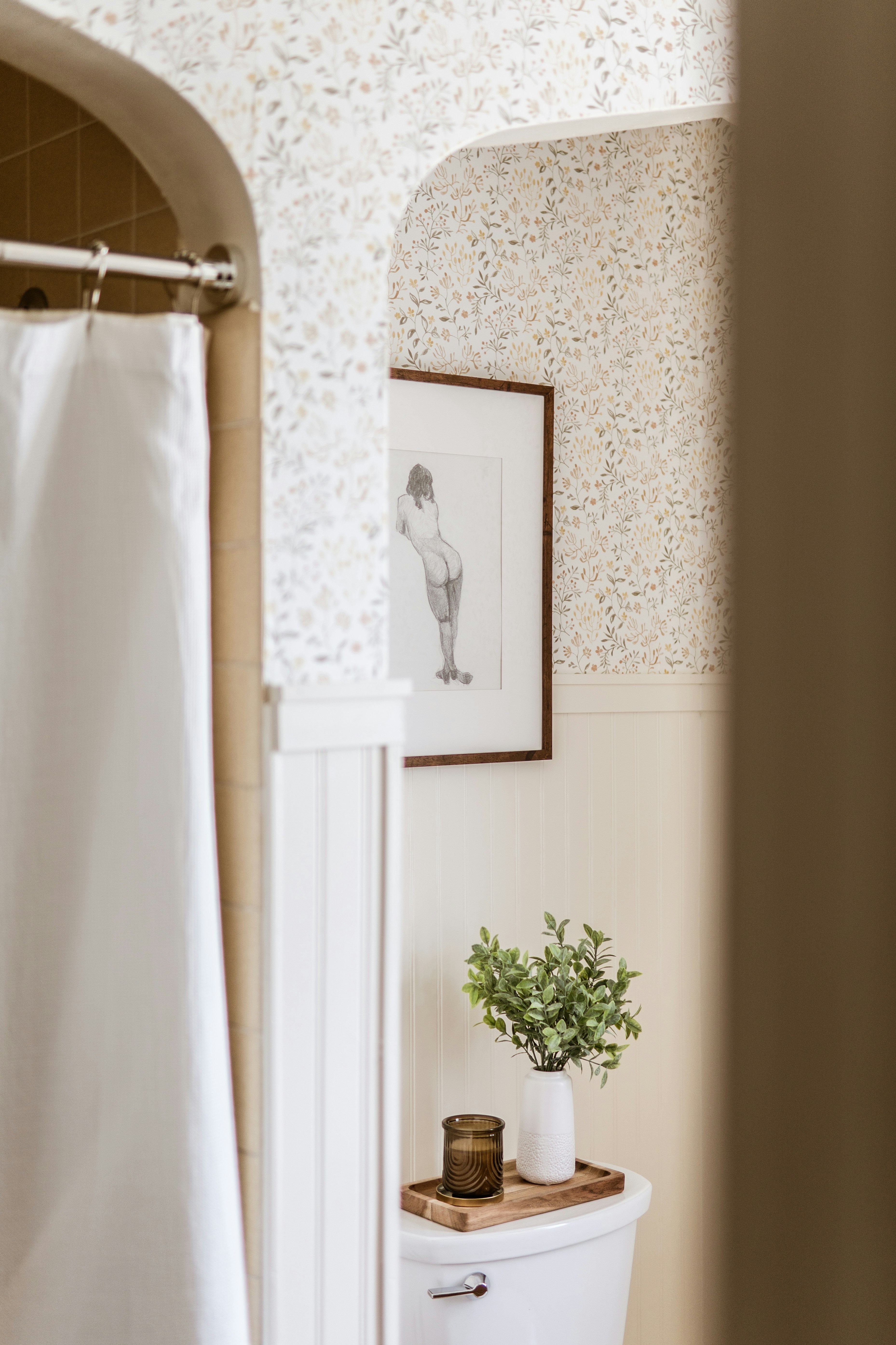 A Quiet Corner: Plant, Portrait, and Soft Light in a Vintage Bath