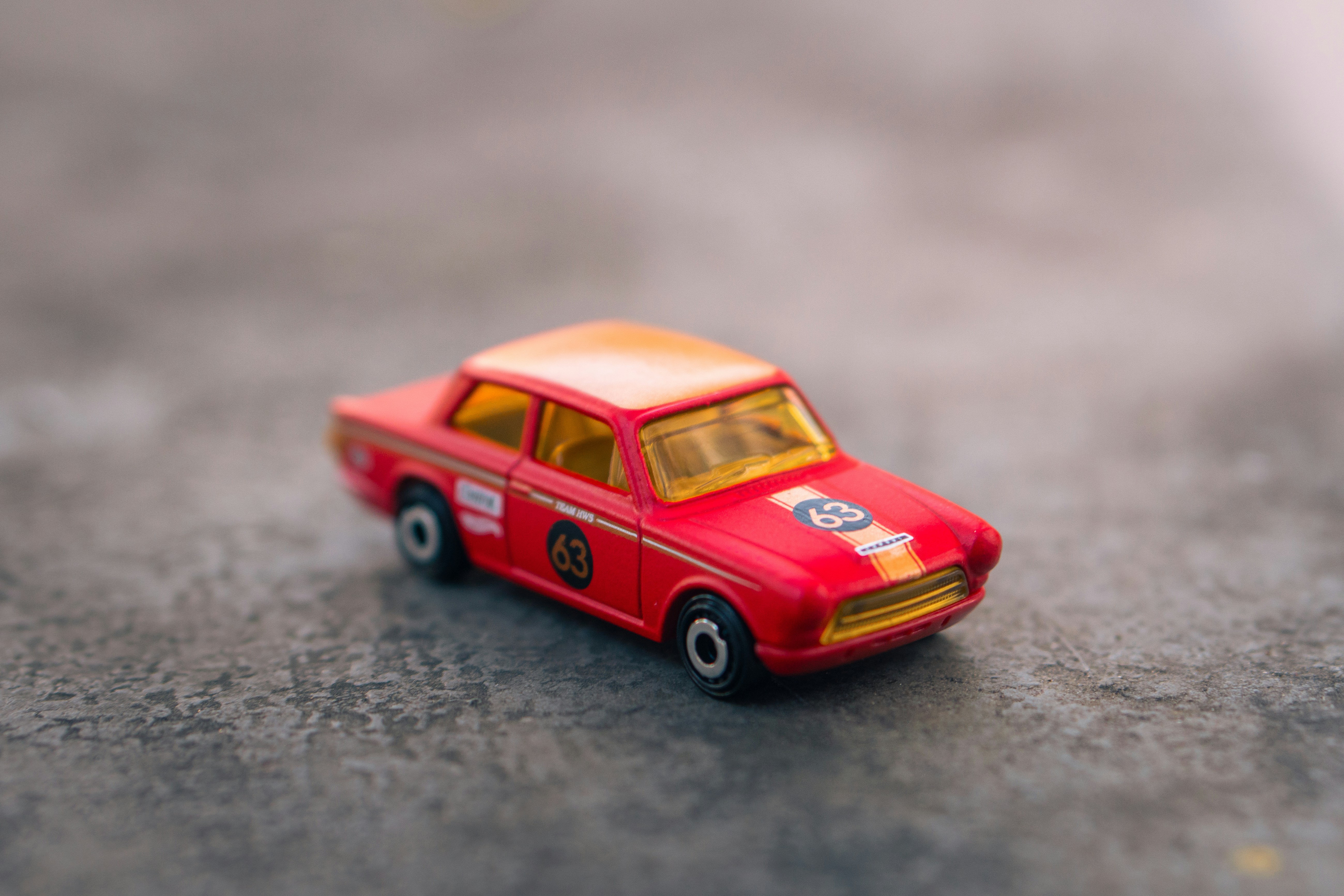 Mini Racer on a Painted Road: A Close-Up of a Red Vintage Toy Car