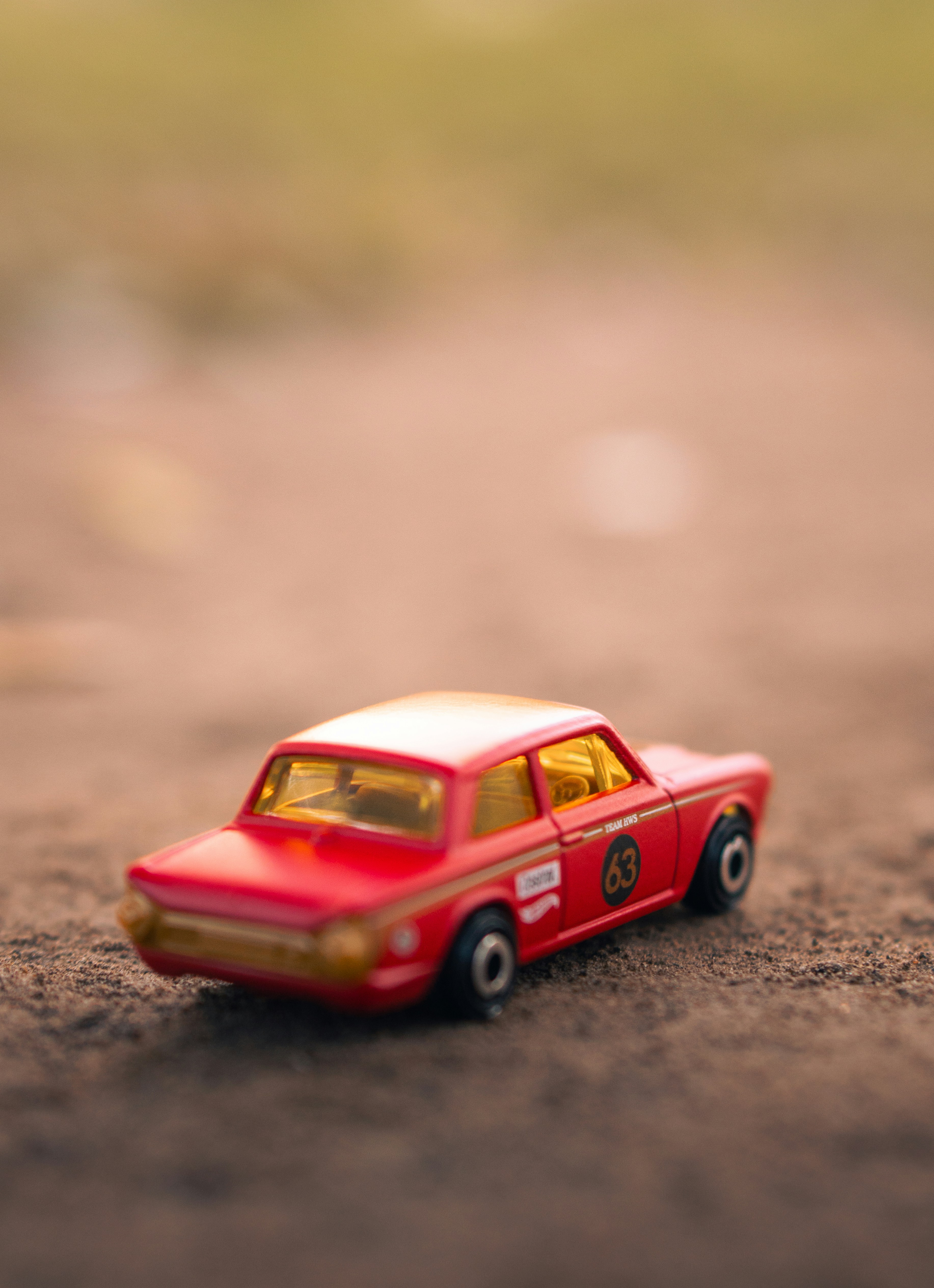 Mini red racer on a sunlit dirt track